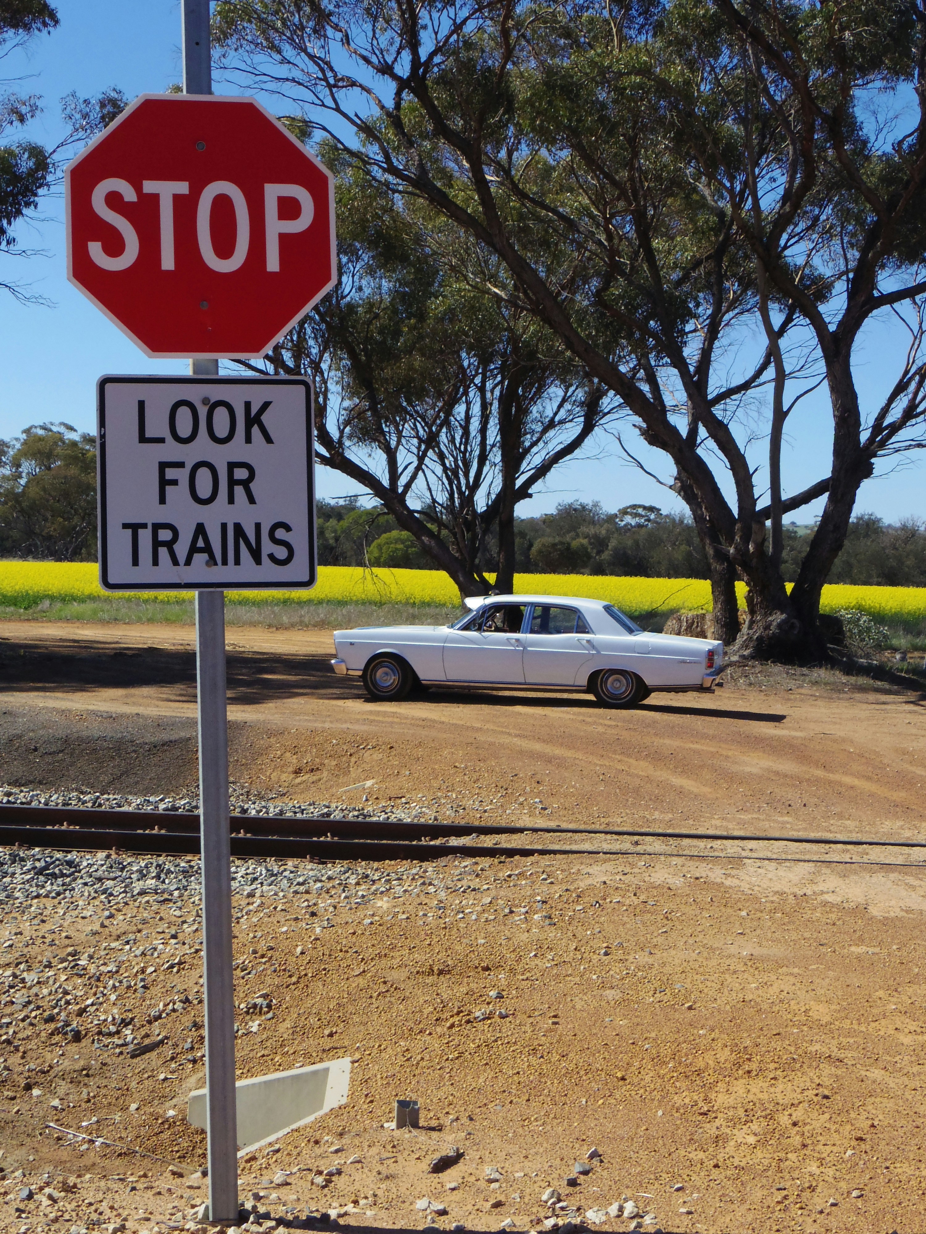Stop Sign and Vintage Car at a Rural Crossing