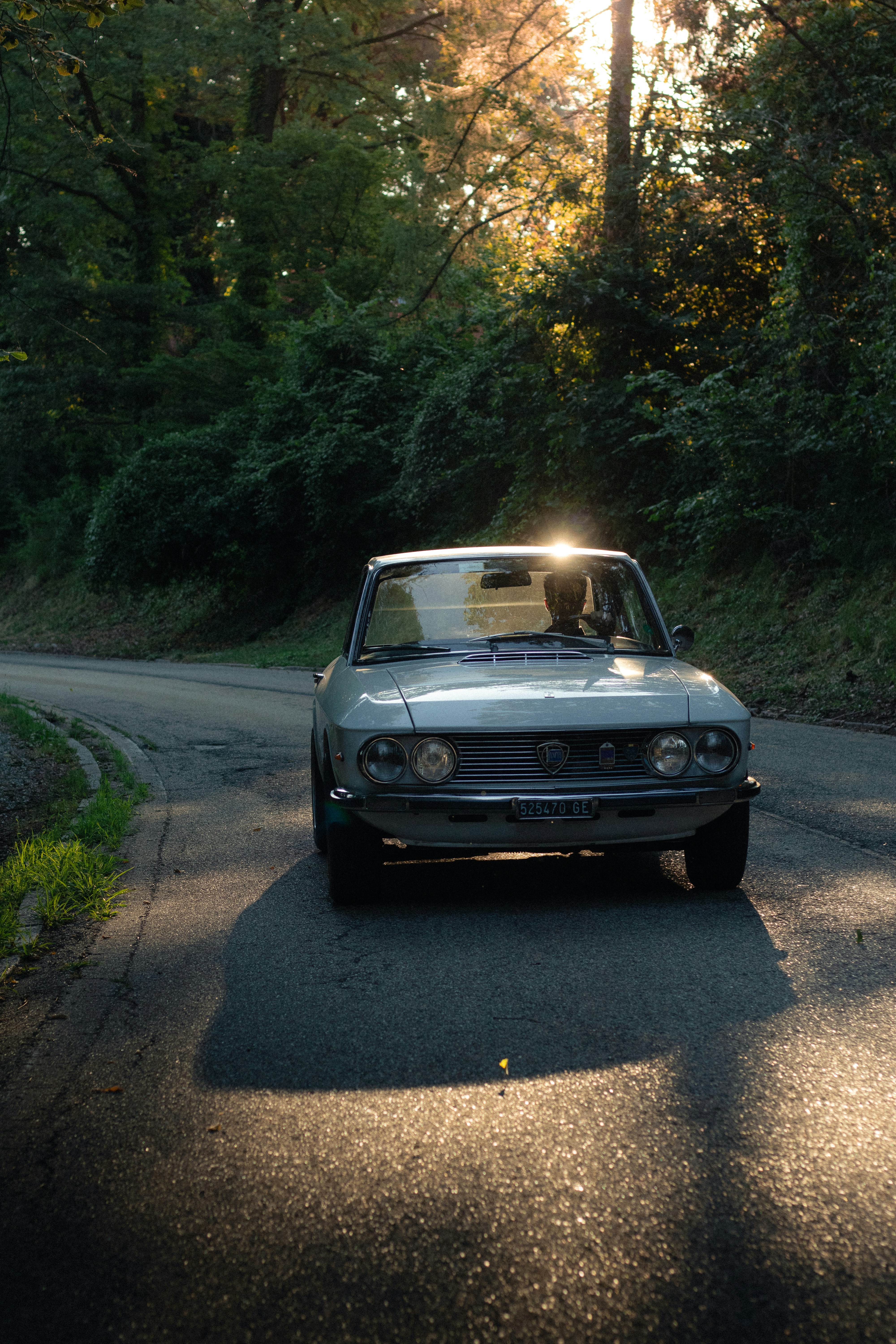 Sunlit Horizon: Classic Lancia Meets the Dappled Road