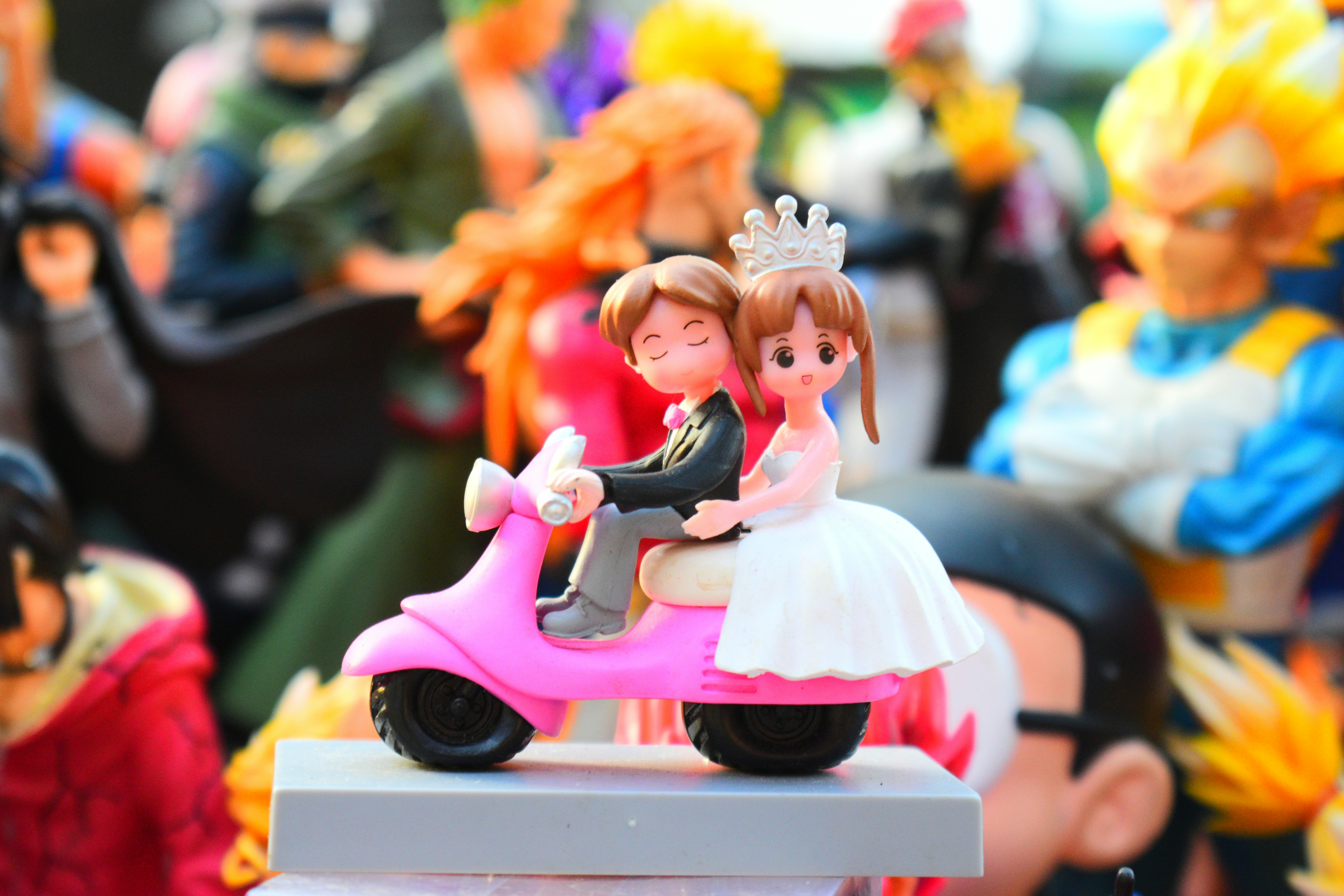 Joyful Ride: A Tiny Royal Couple on a Pink Scooter