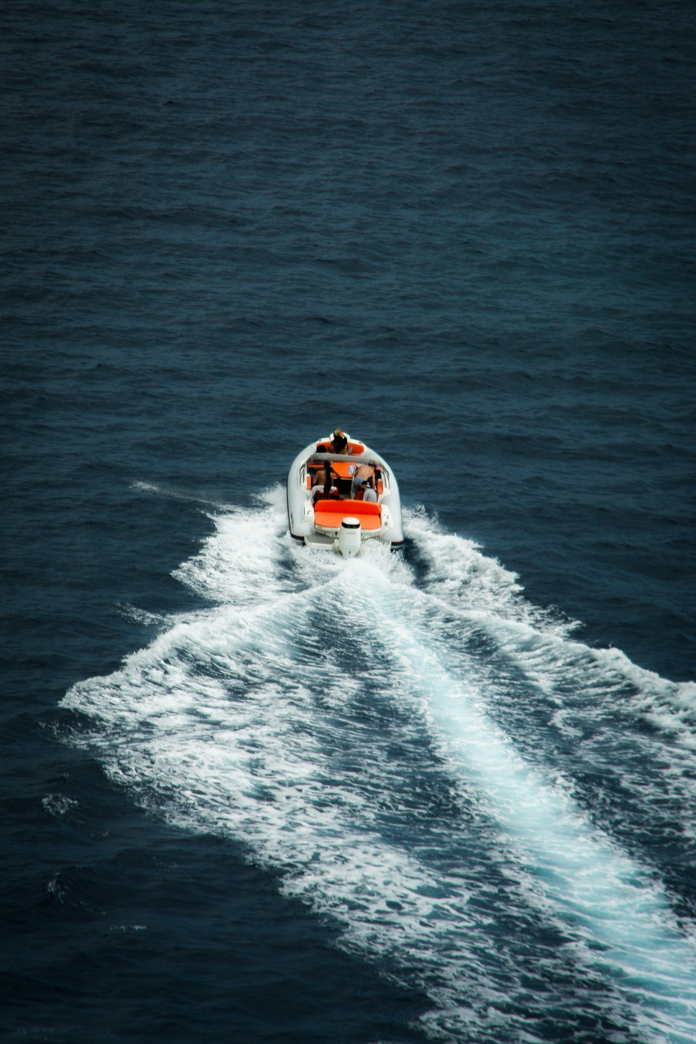 Speeding Toward the Horizon: A Bright Passenger Boat Carves a White Wake