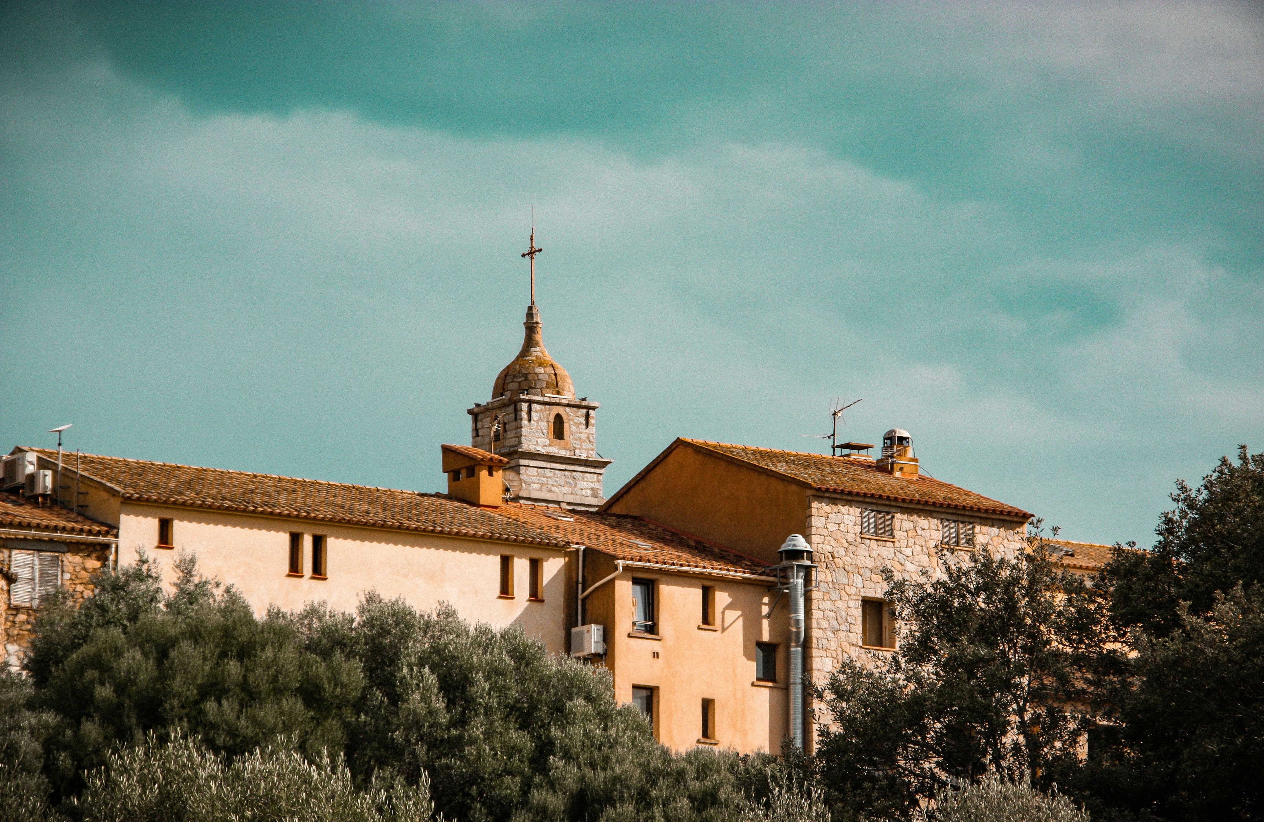 Terracotta Tiled Roofline Under A Turquoise Sky