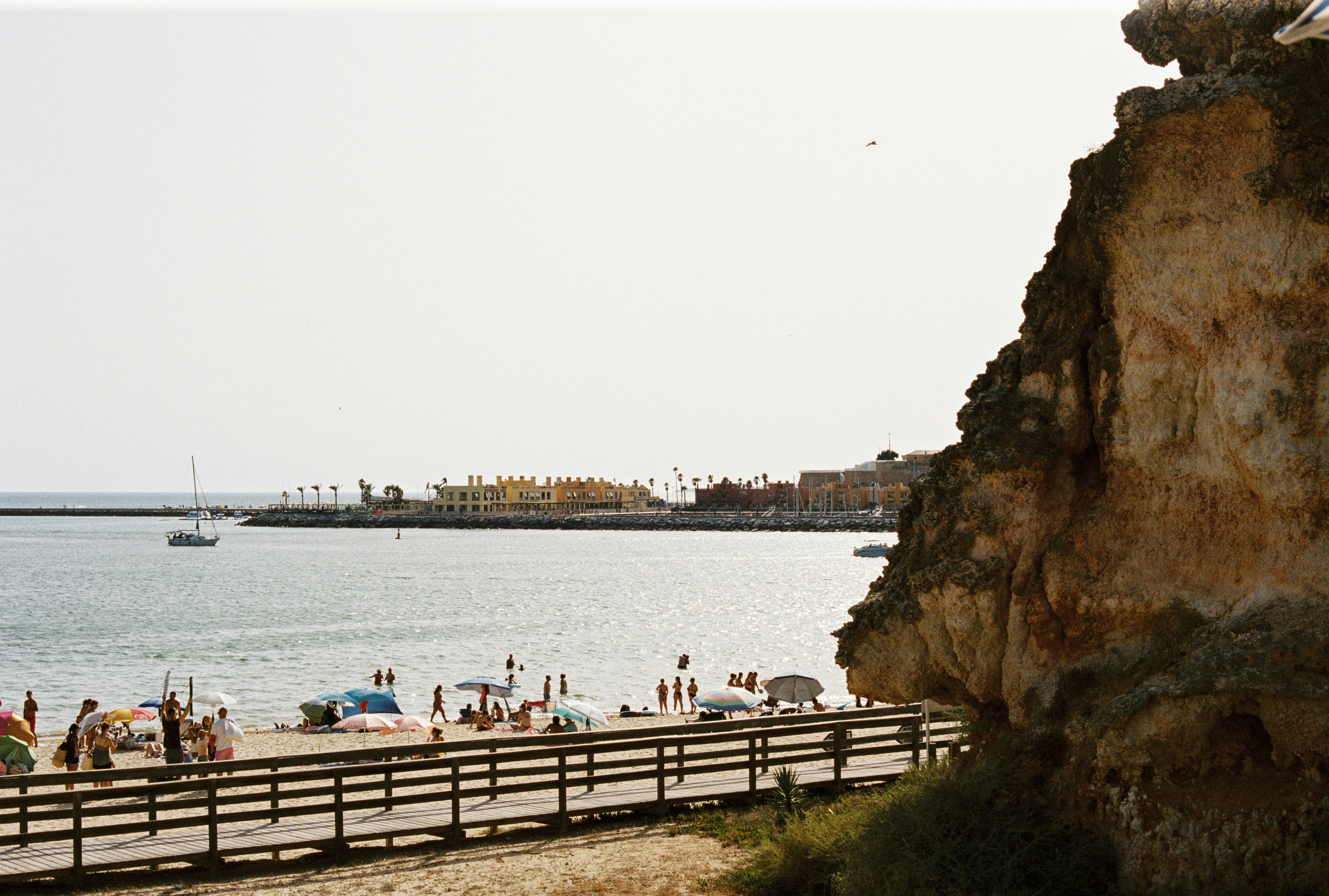 Coastal Playground: People, Pier, and Cliffside silhouette