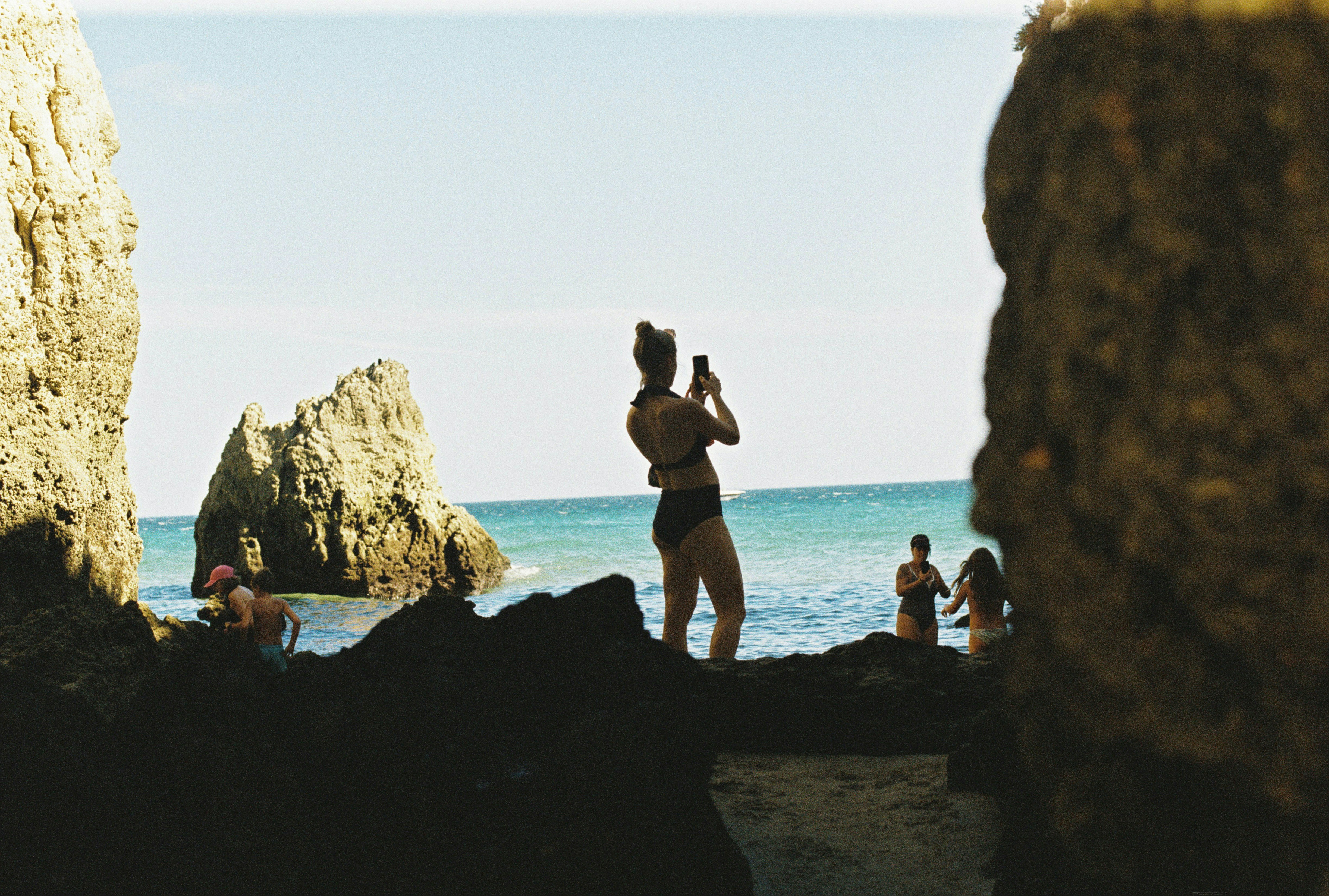Sunlit shoreline portrait between rugged silhouettes