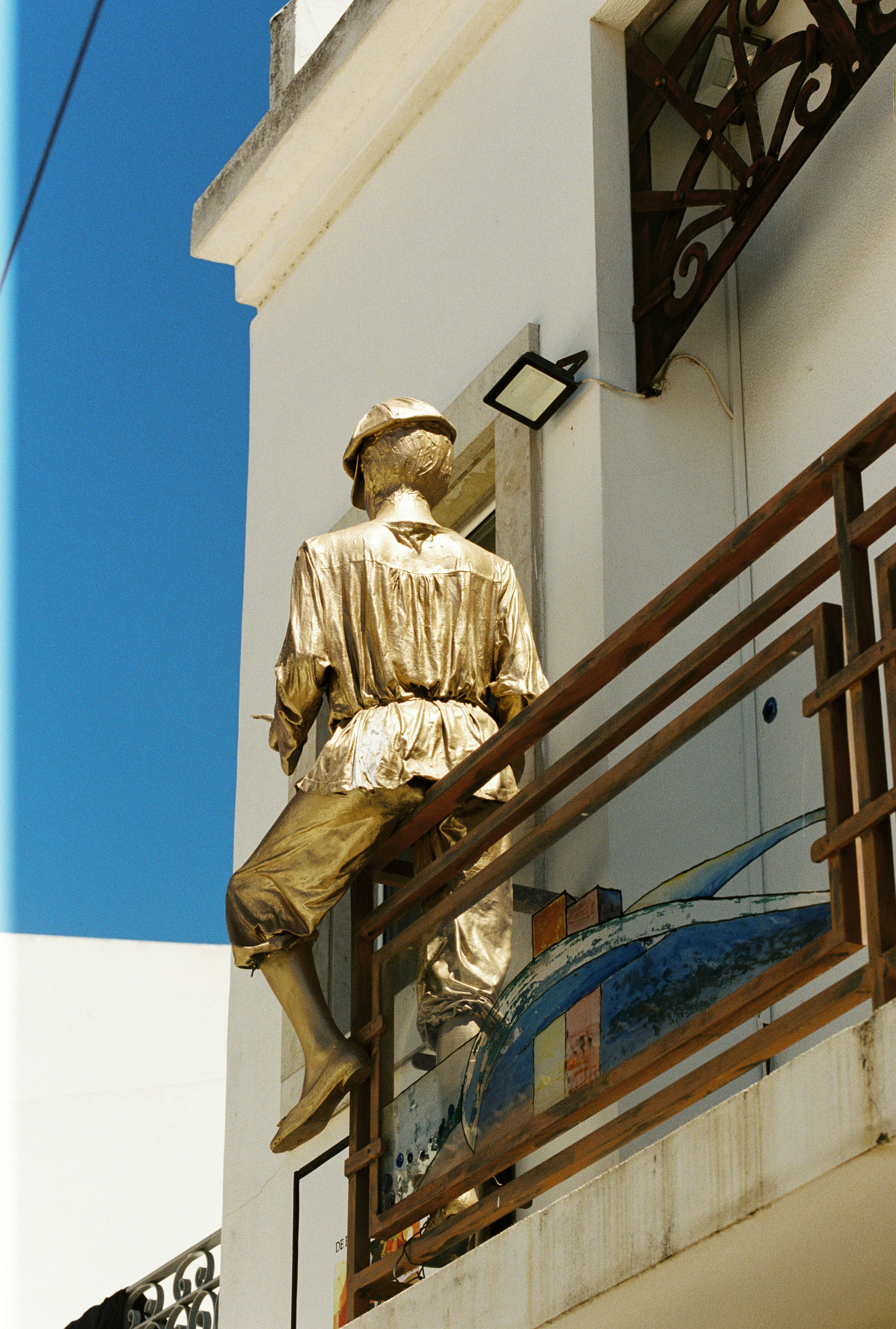 Golden Statue in Sunlit Balcony Overlook