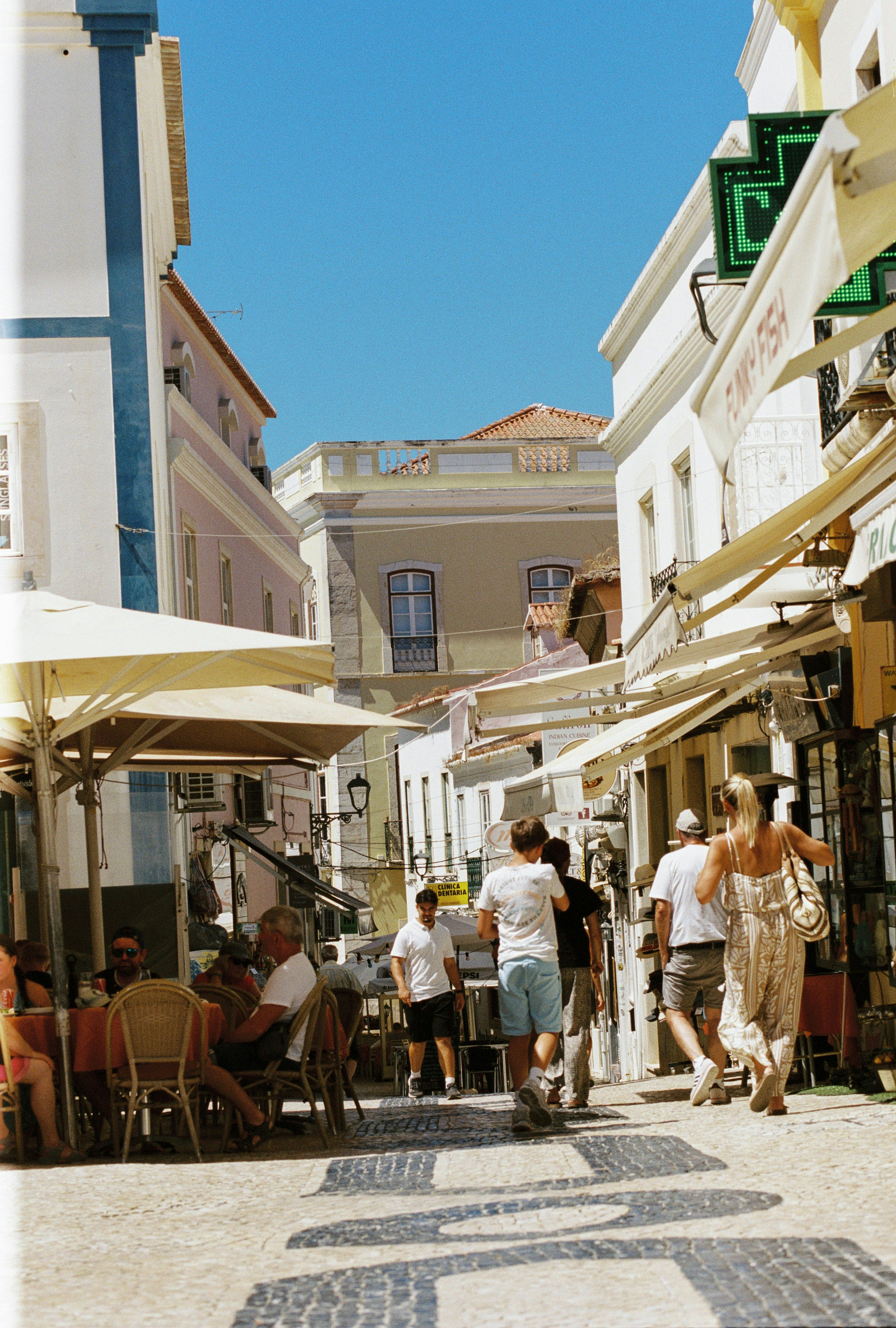Cobbled Street Café Runners Under a Bright Greek-Blue Sky