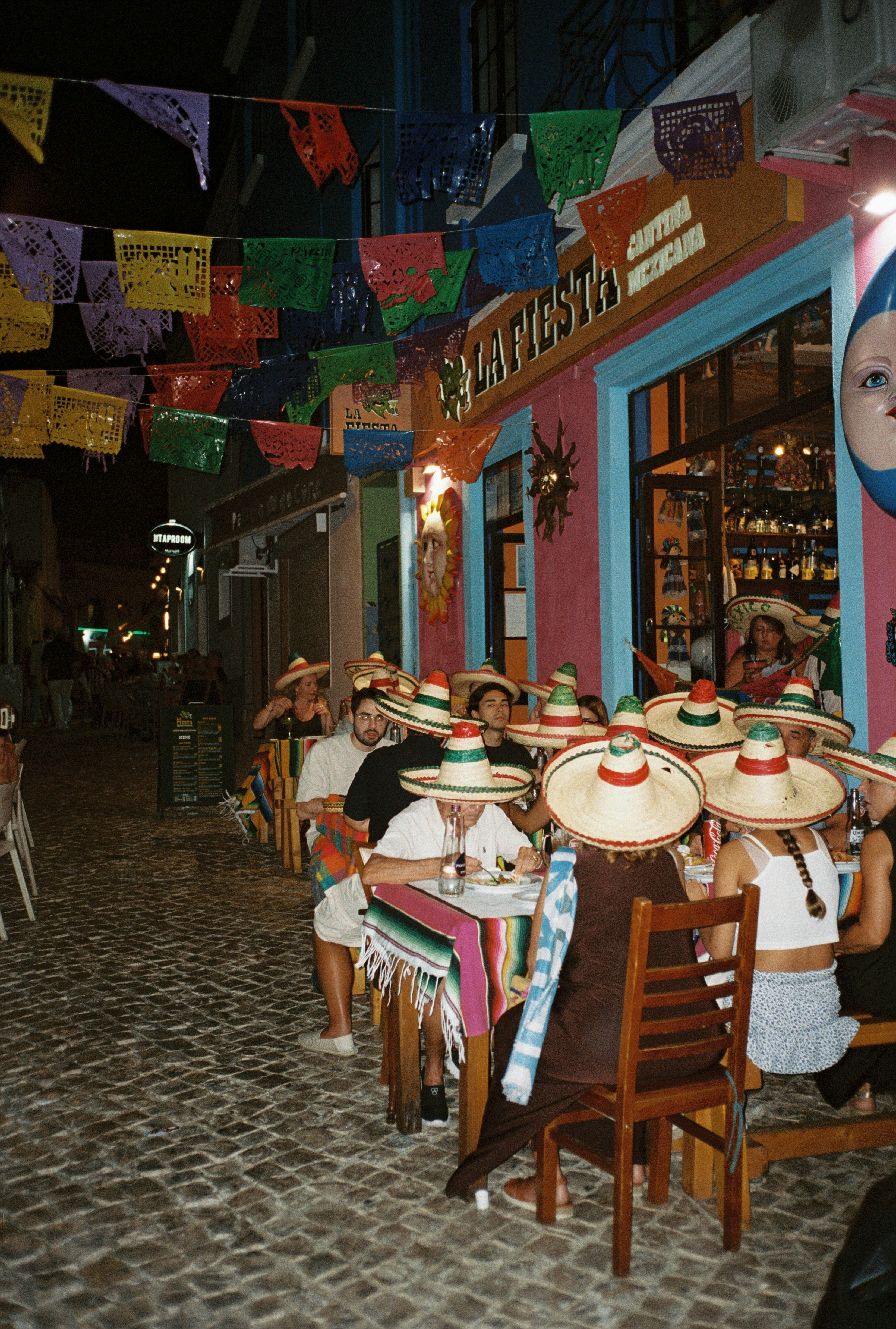 Lively Cantina Portrait: Striped Hats and Night Market Cheer