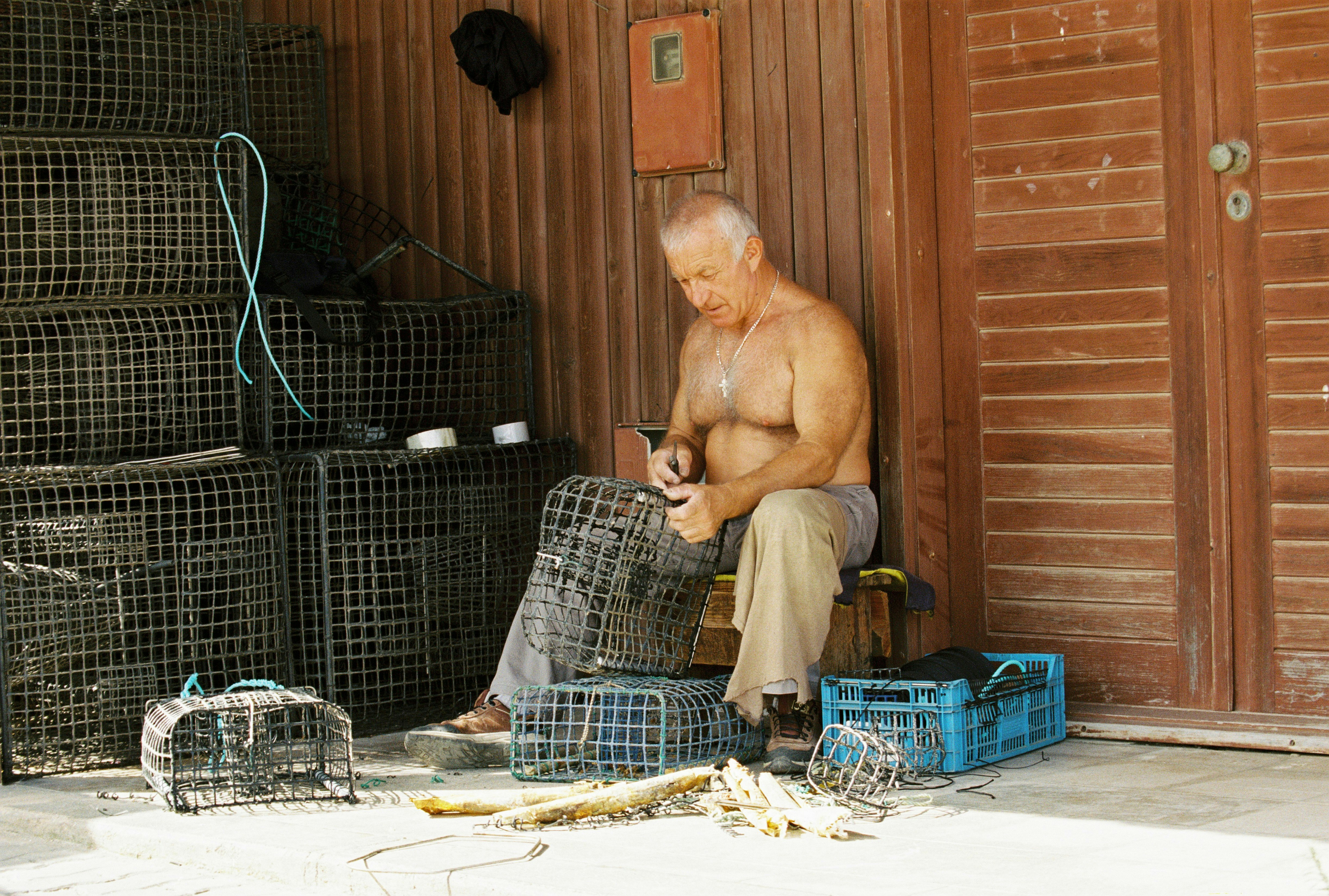 Sitting Craftsman: Aging Hands and Tools in Quiet Workshop