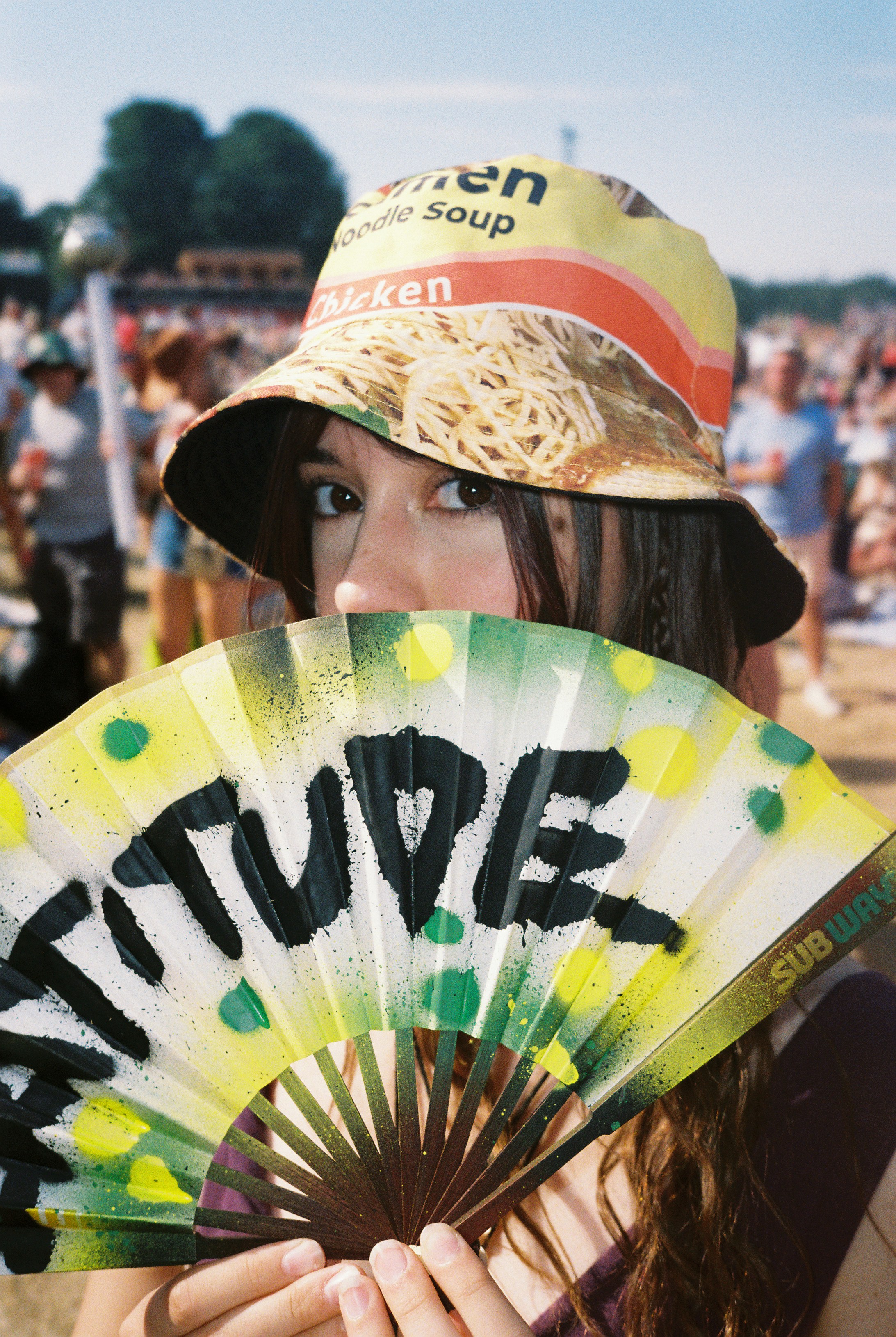 Hidden Smile Behind a Colorful Fan