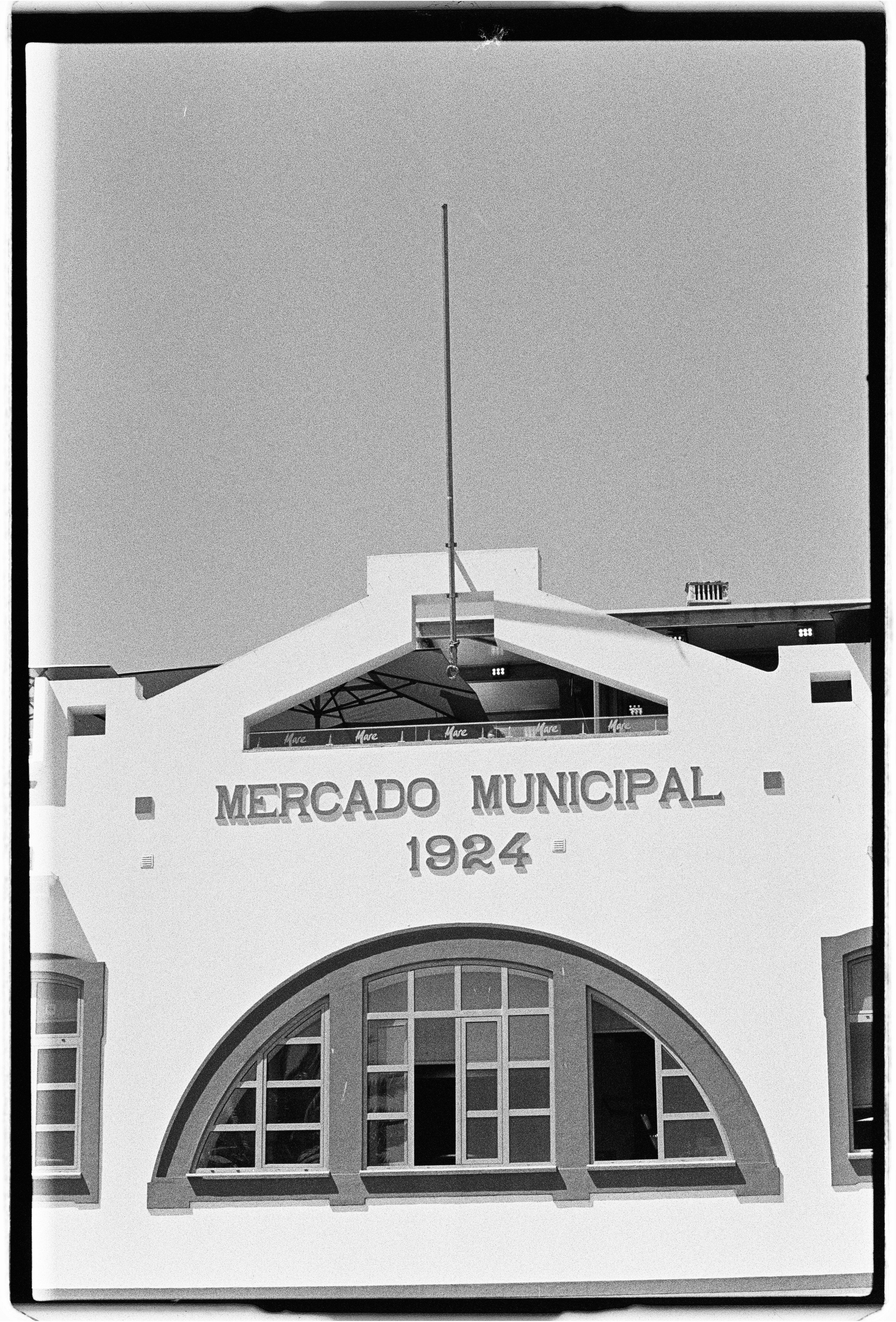 Mercado Municipal Facade: Arch Windows Beneath a Triangular Crest