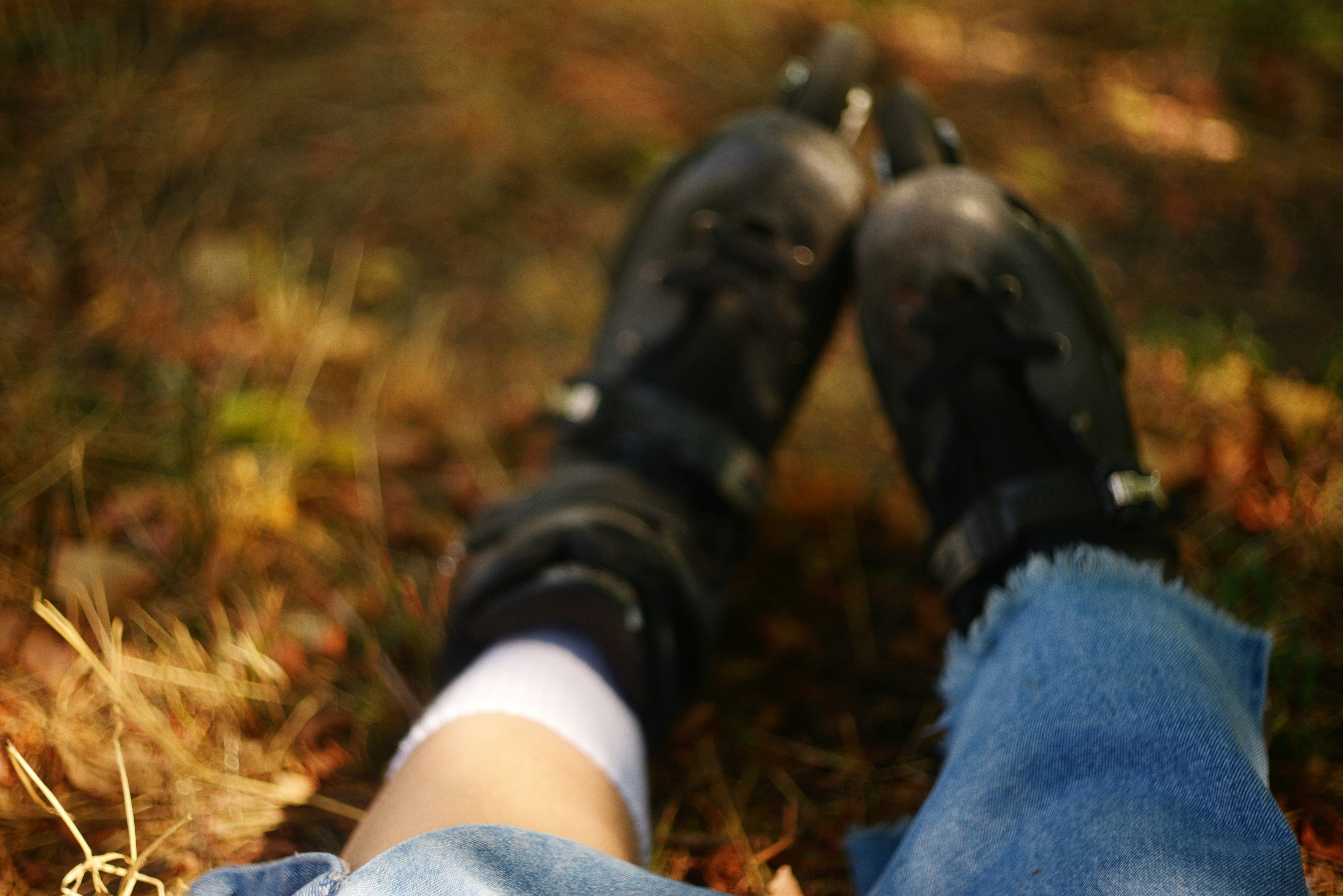 Grounded in Color: Feet and Boots Beneath Autumn Leaves