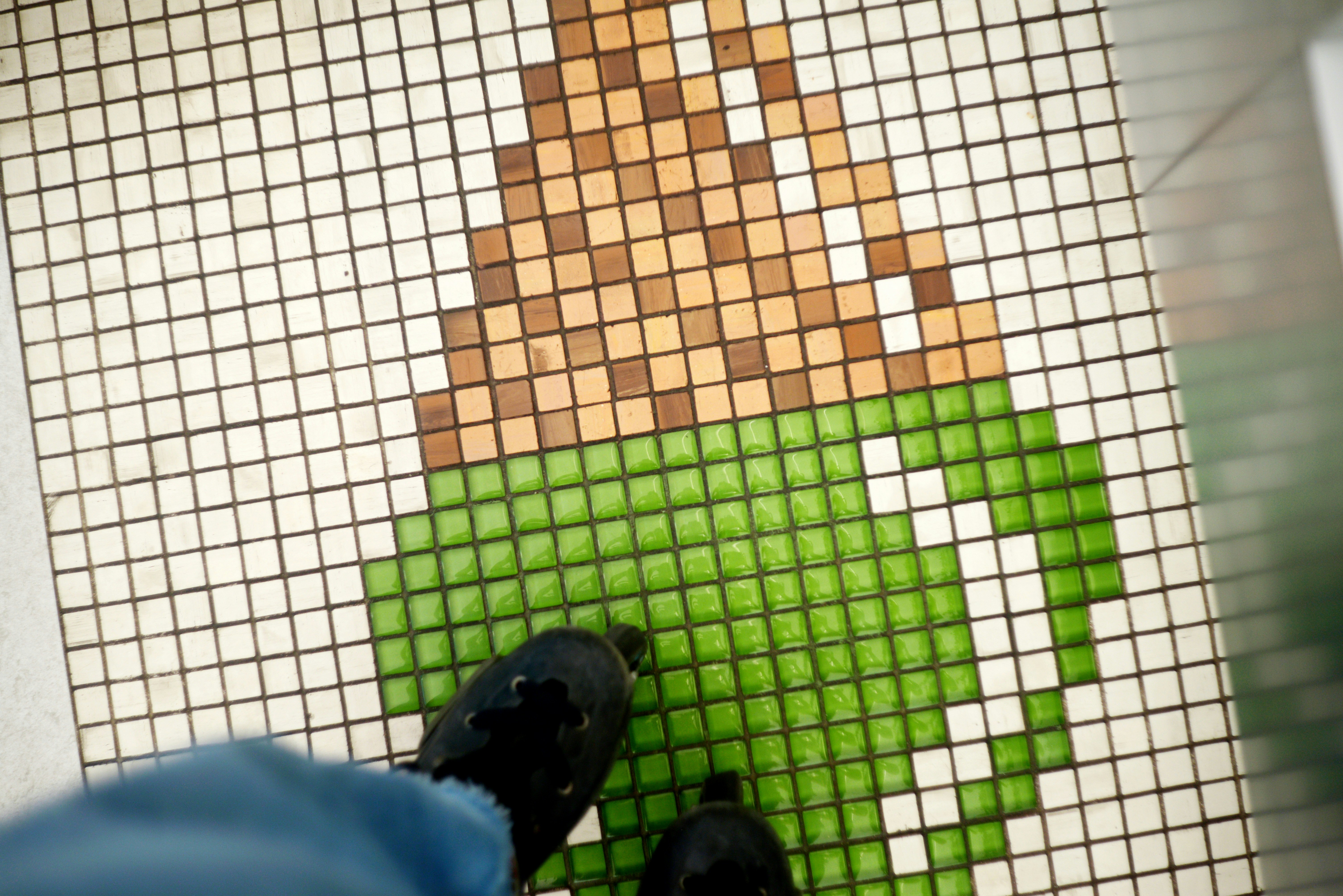 Mosaic Tread: A Green Pixelated Mug Shot in Tiles