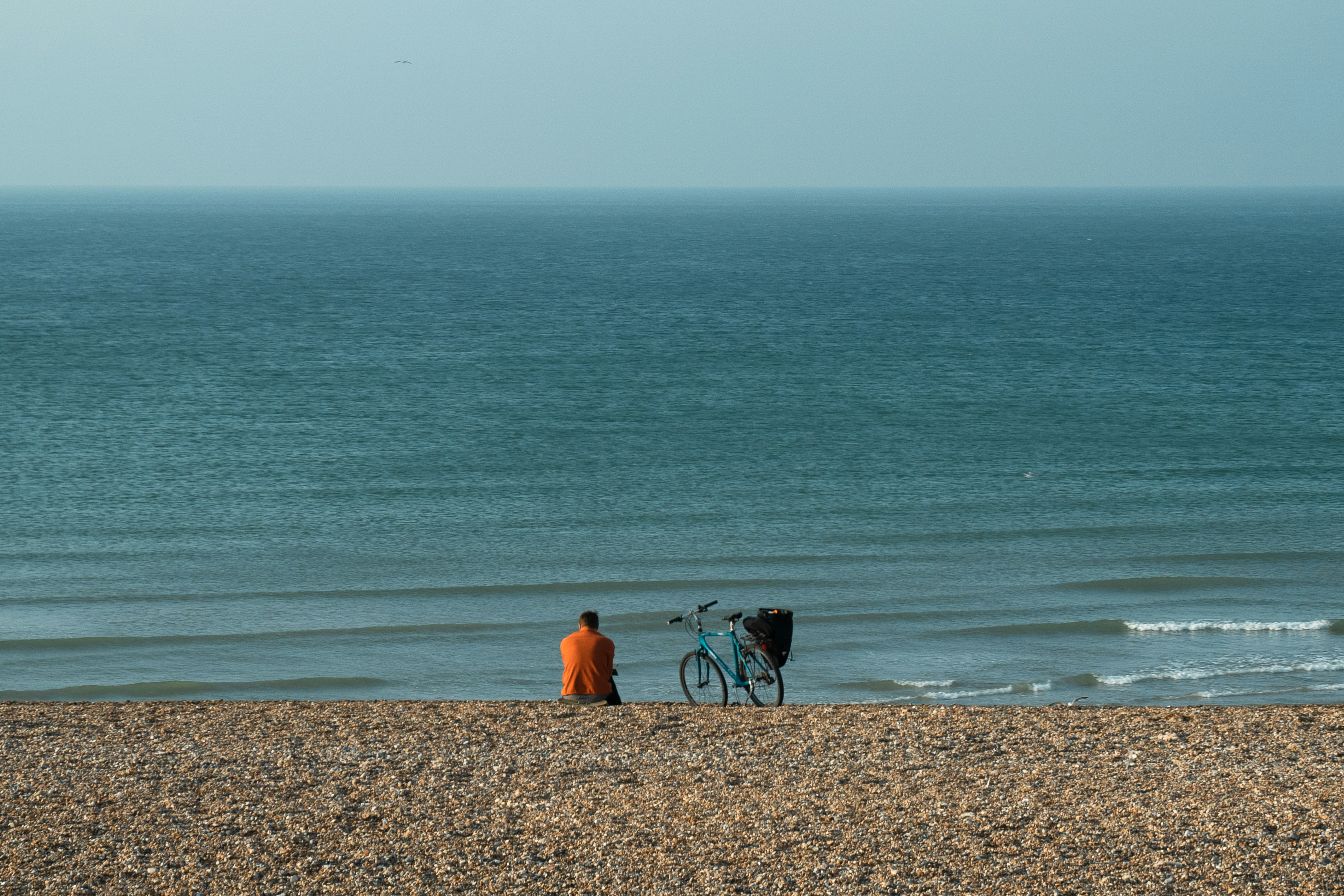  solitary figure and bicycle by the sea
