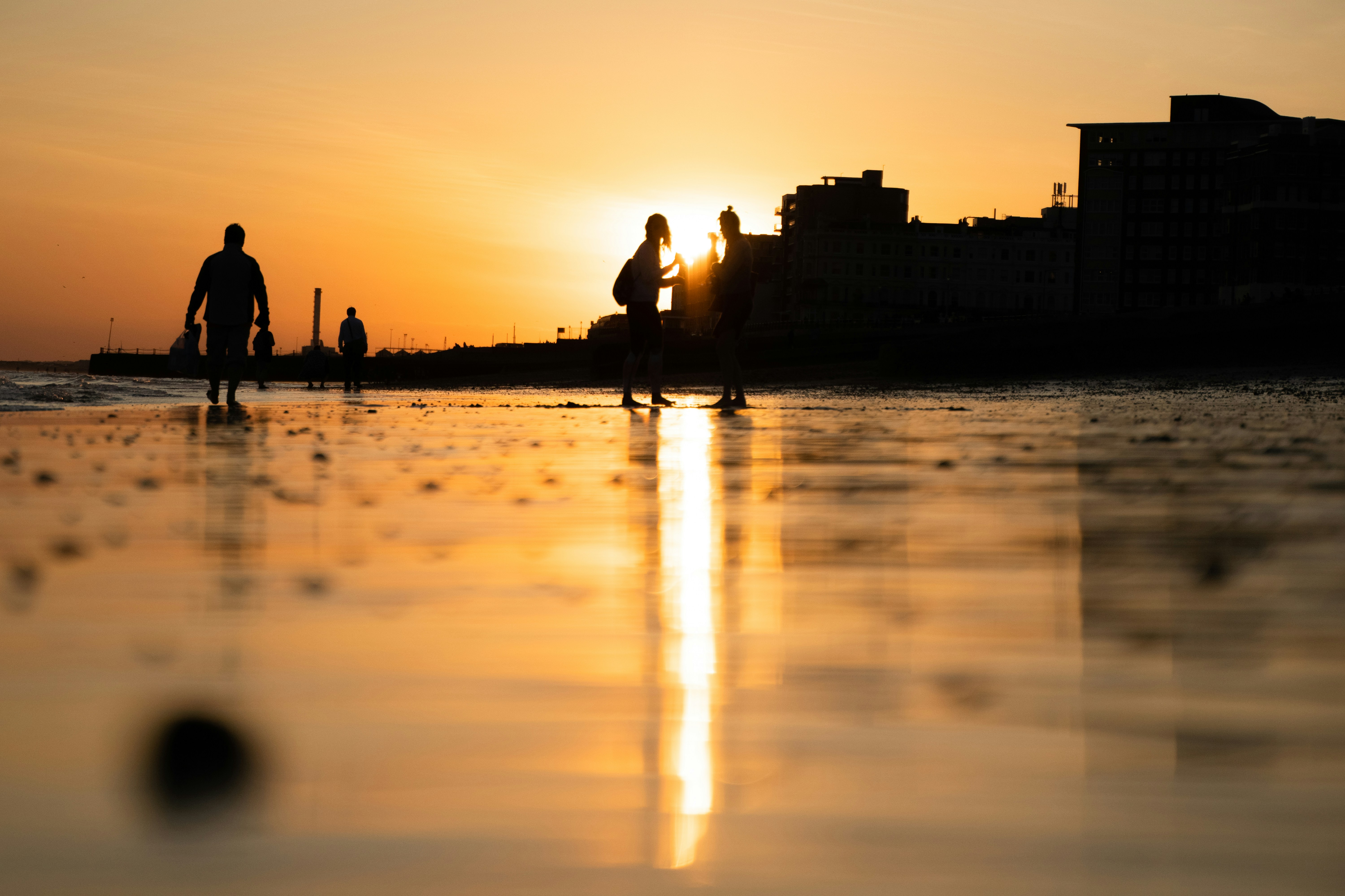 Silhouettes at Dusk: Walking Toward the Glow