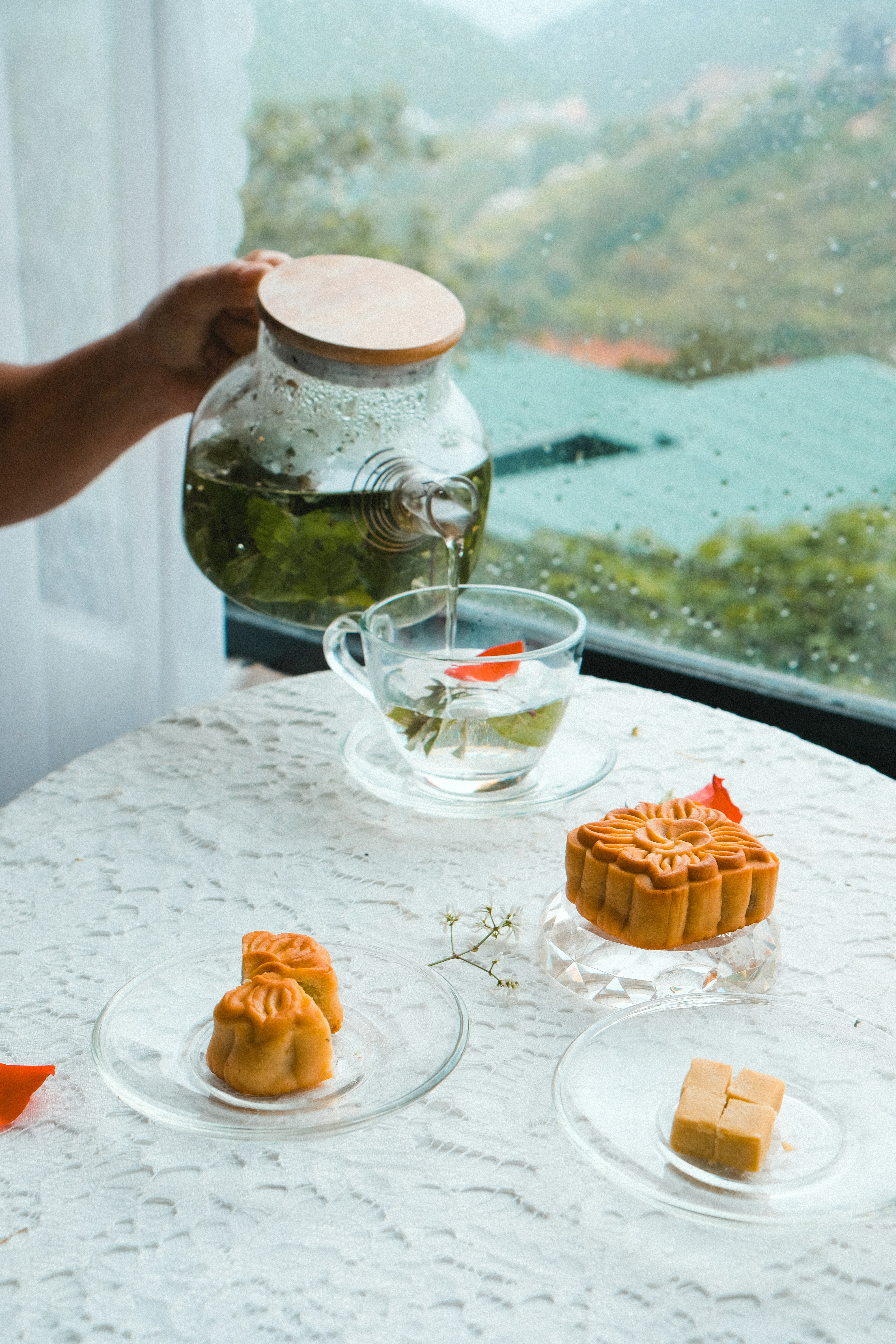 Teapot of Tea and Treats on a Lace Table by Rain-Kissed Window
