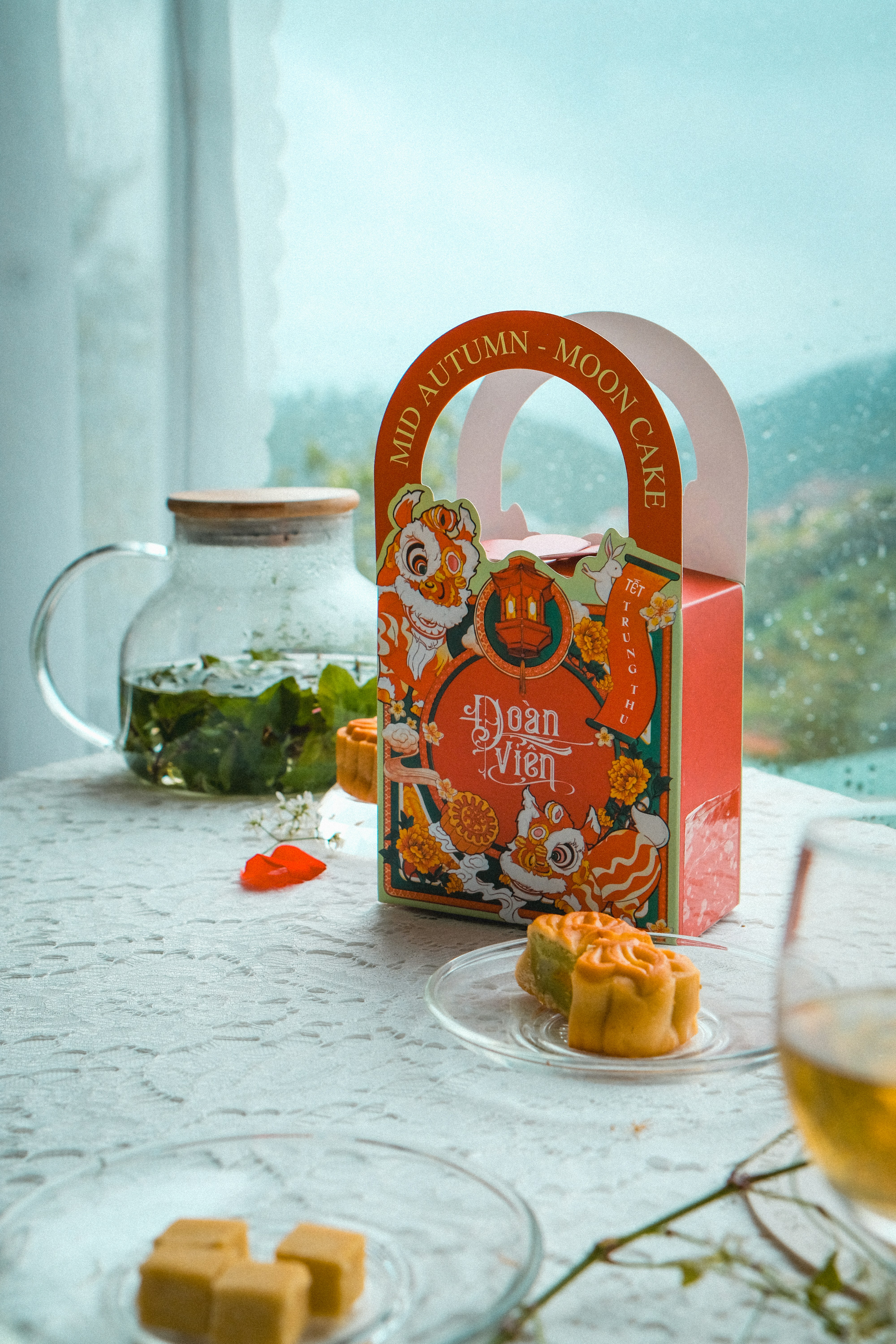 Mooncake Box on a Lace Table with Tea and Treats