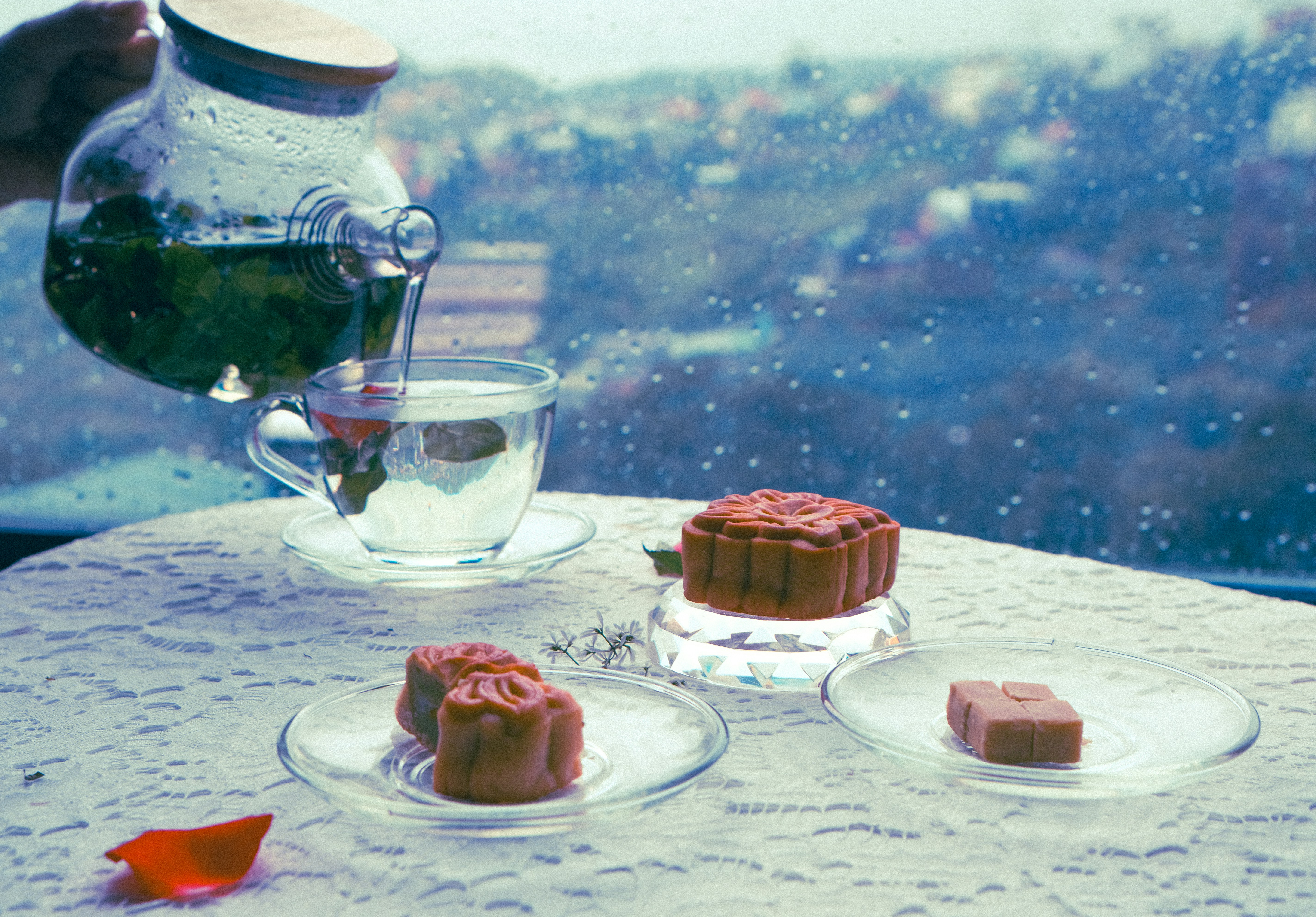 Floating tea, crafted treats: a tiny still life scene by the window