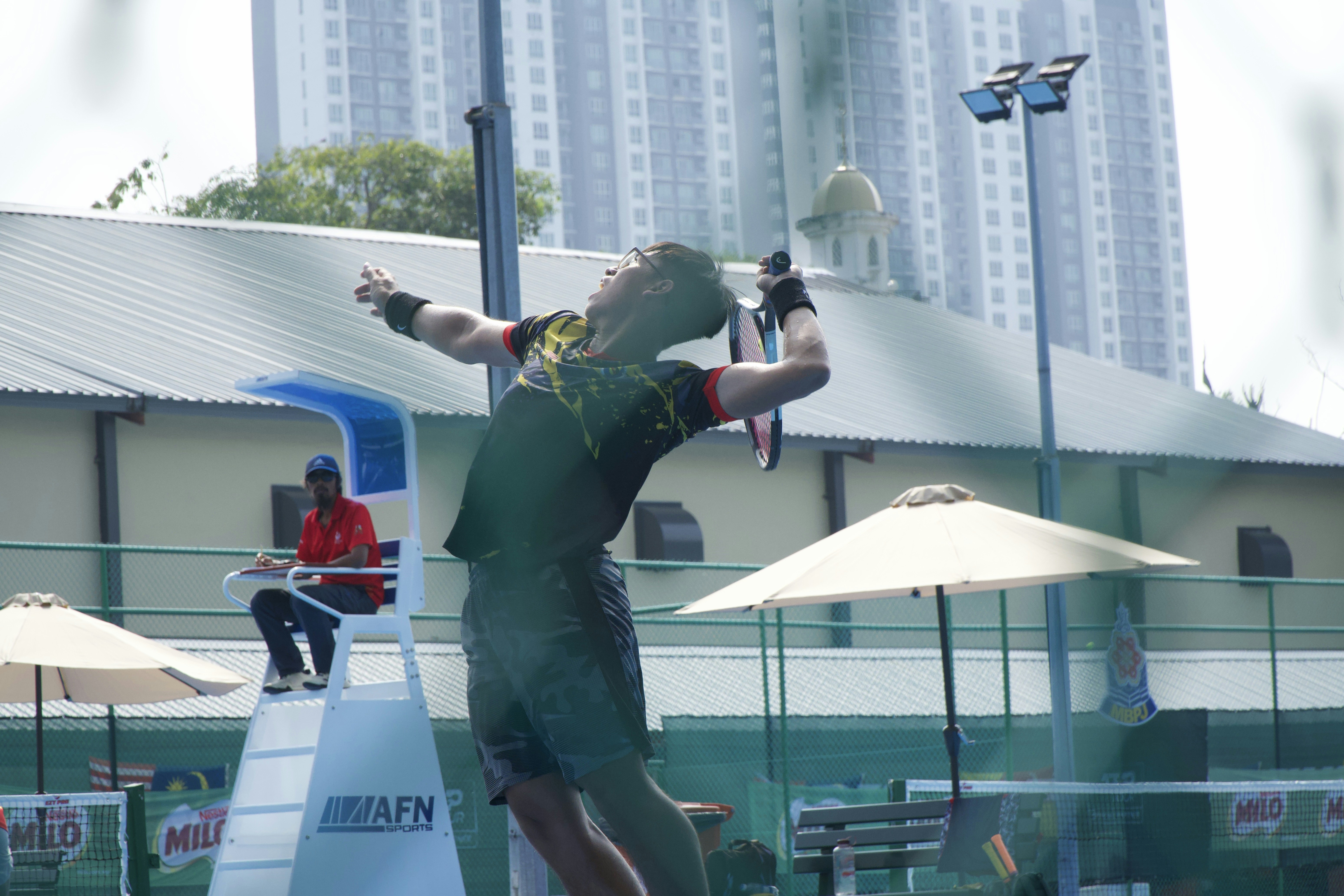 Aerial Leap: Handcatcher in a Sunset of Concrete Towers