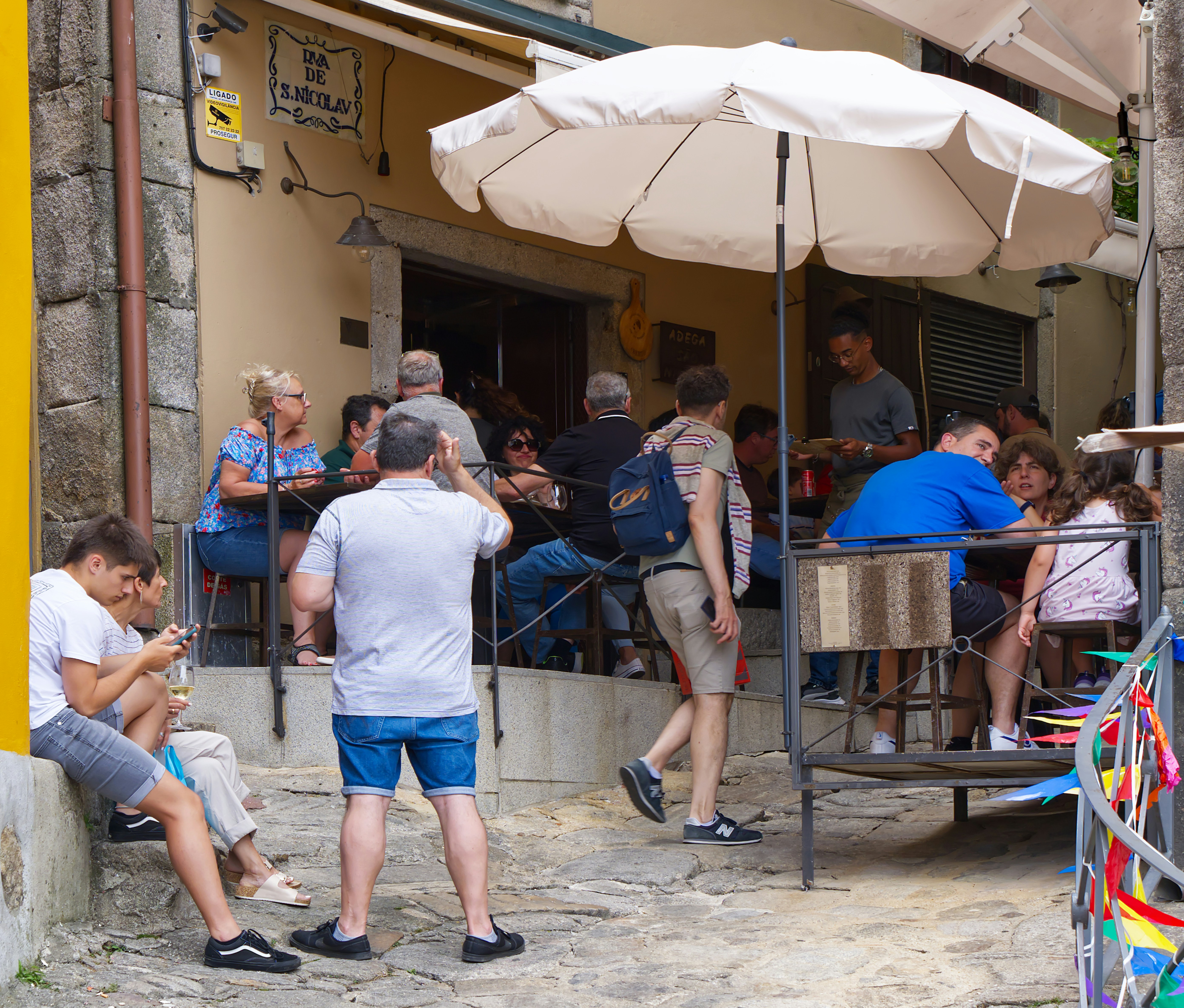 Cafe Terrace in a Sunlit European Alley