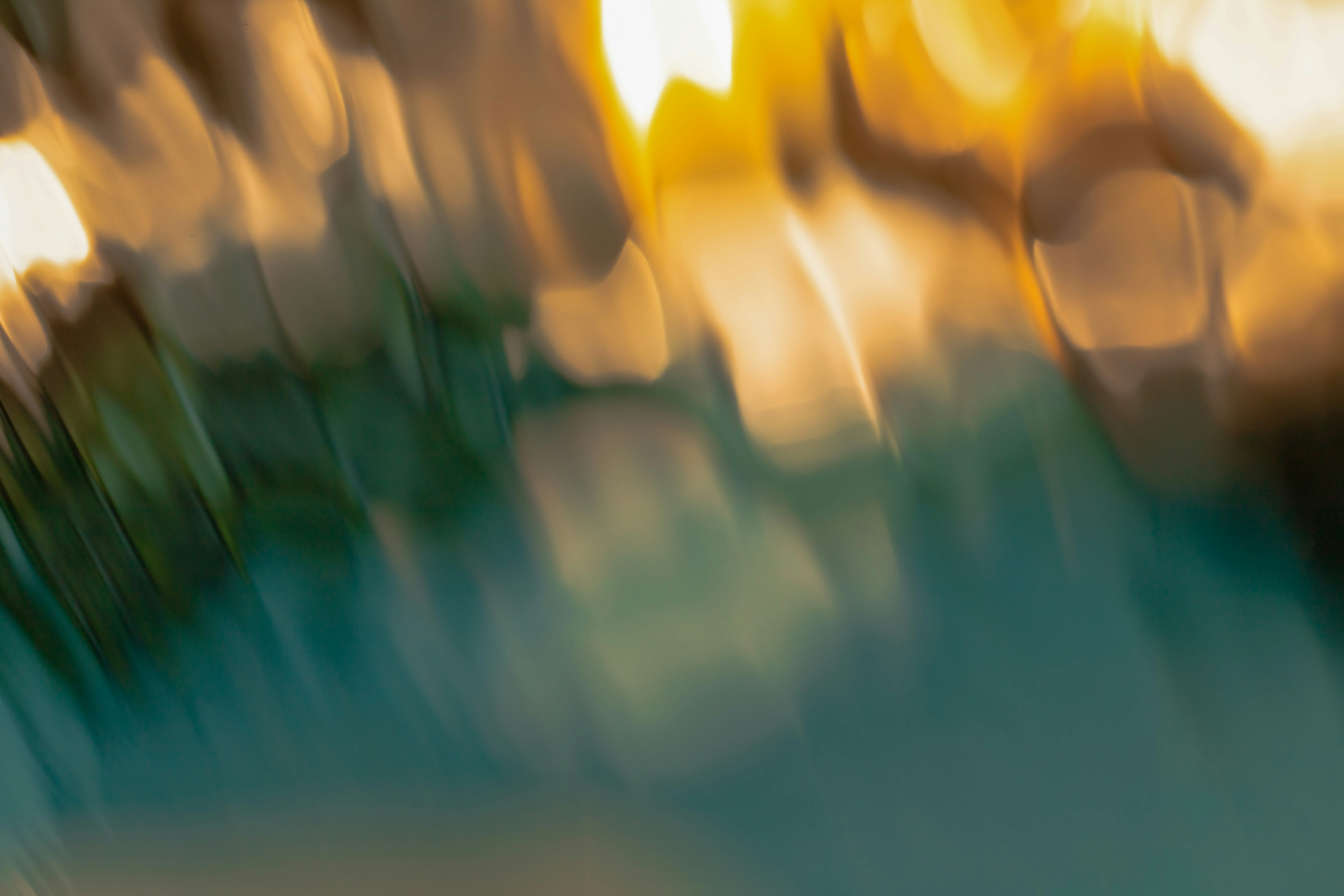 Blurred Horizon: Golden Pearls and Cyan Swirl