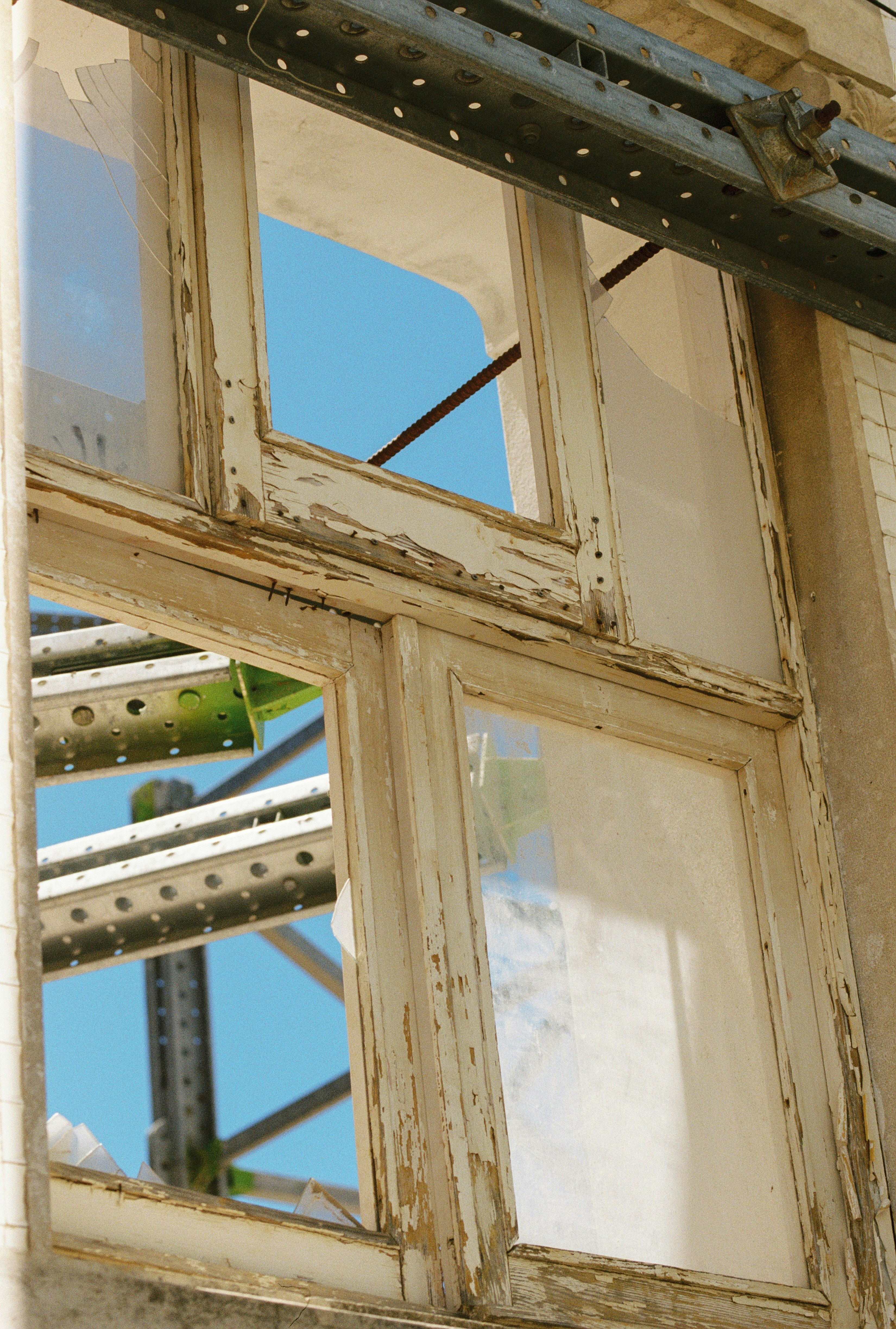 Weathered Window Frame Amidst Construction Scaffolding