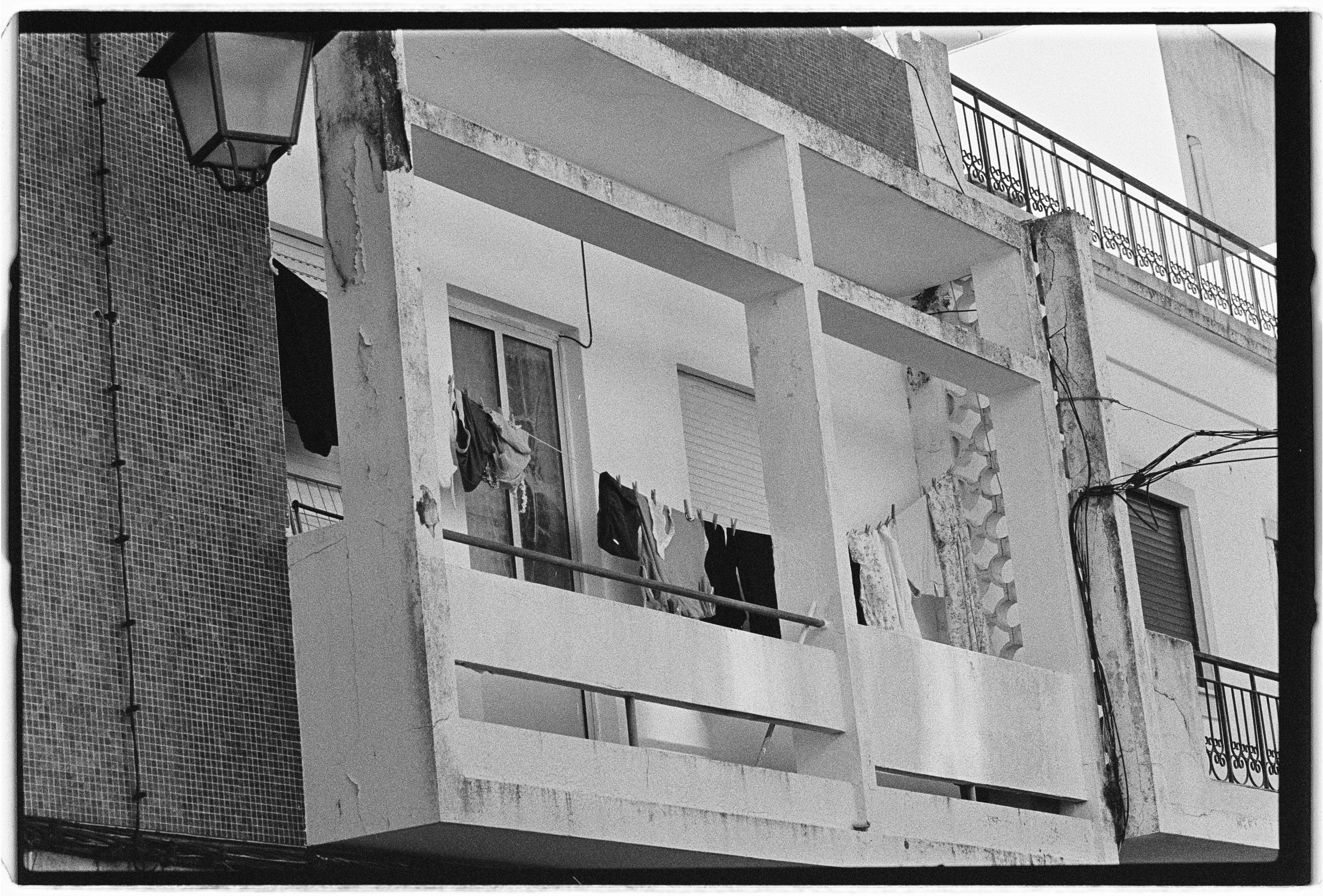 Concrete Balcony Portrait: Laundry Lines Across Urban Facades