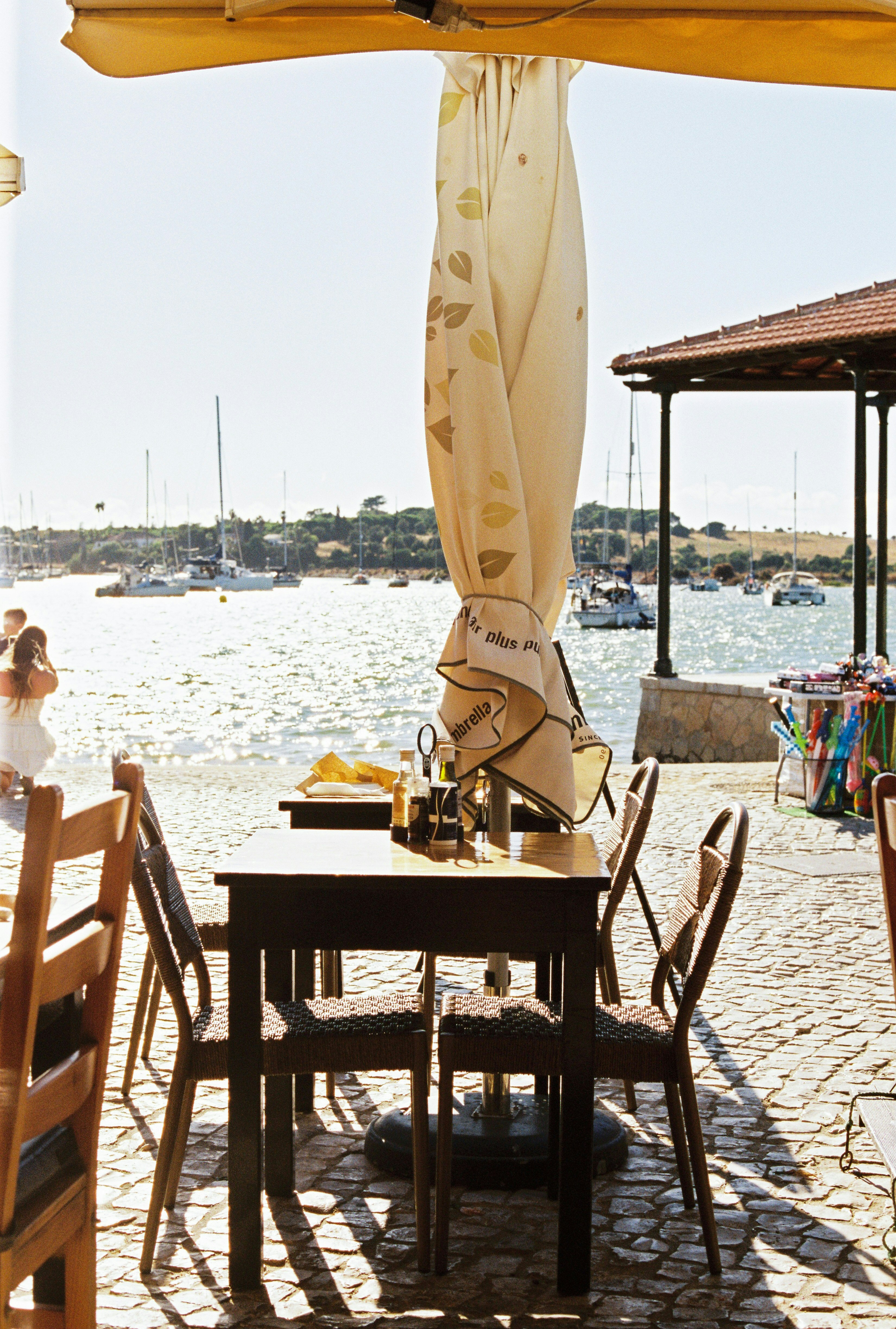Sunlit Terrace by the Marina: A Quiet Table Beside the Water