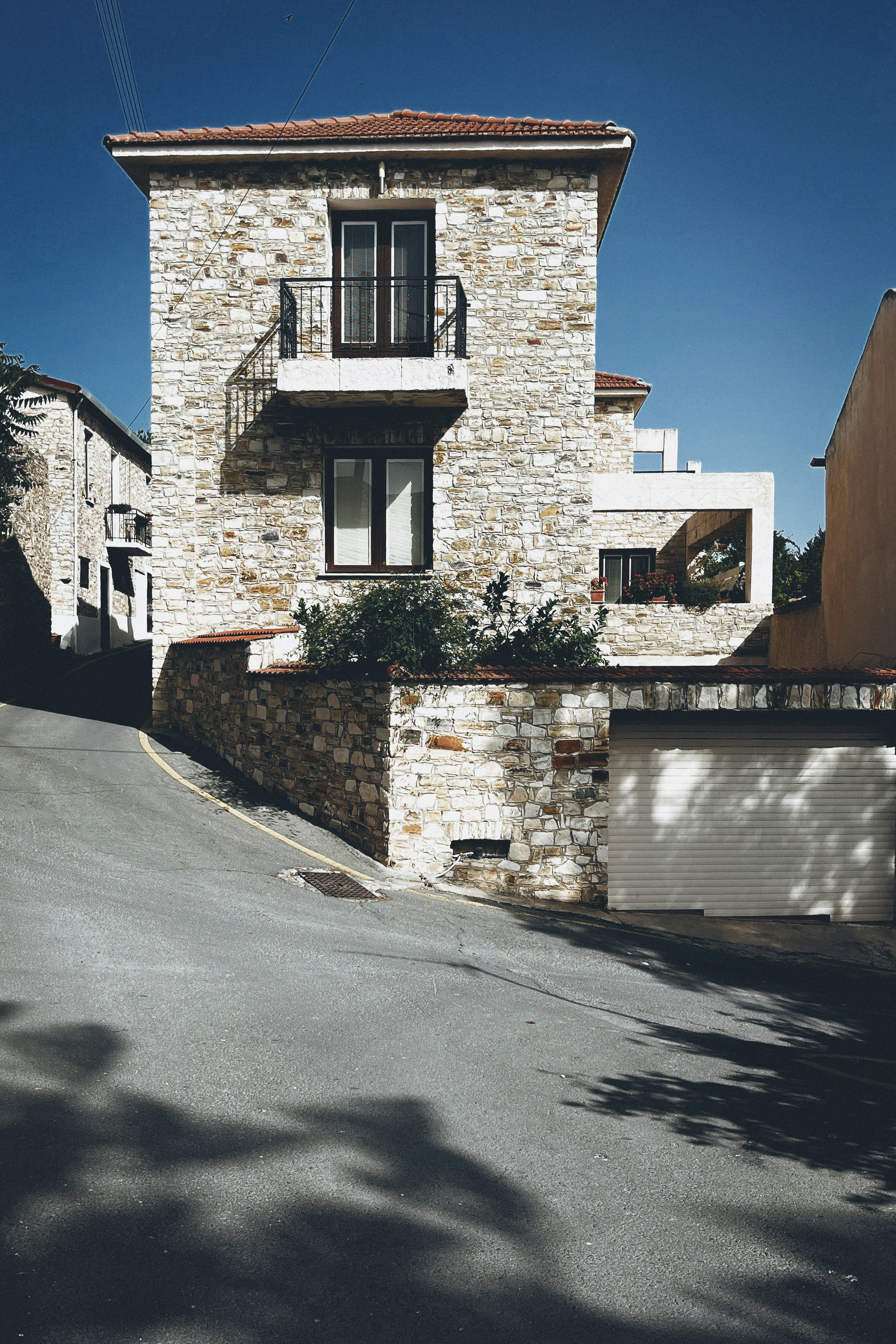 Stone-house Staircase: A Sunlit Corner of Terrace and Gate