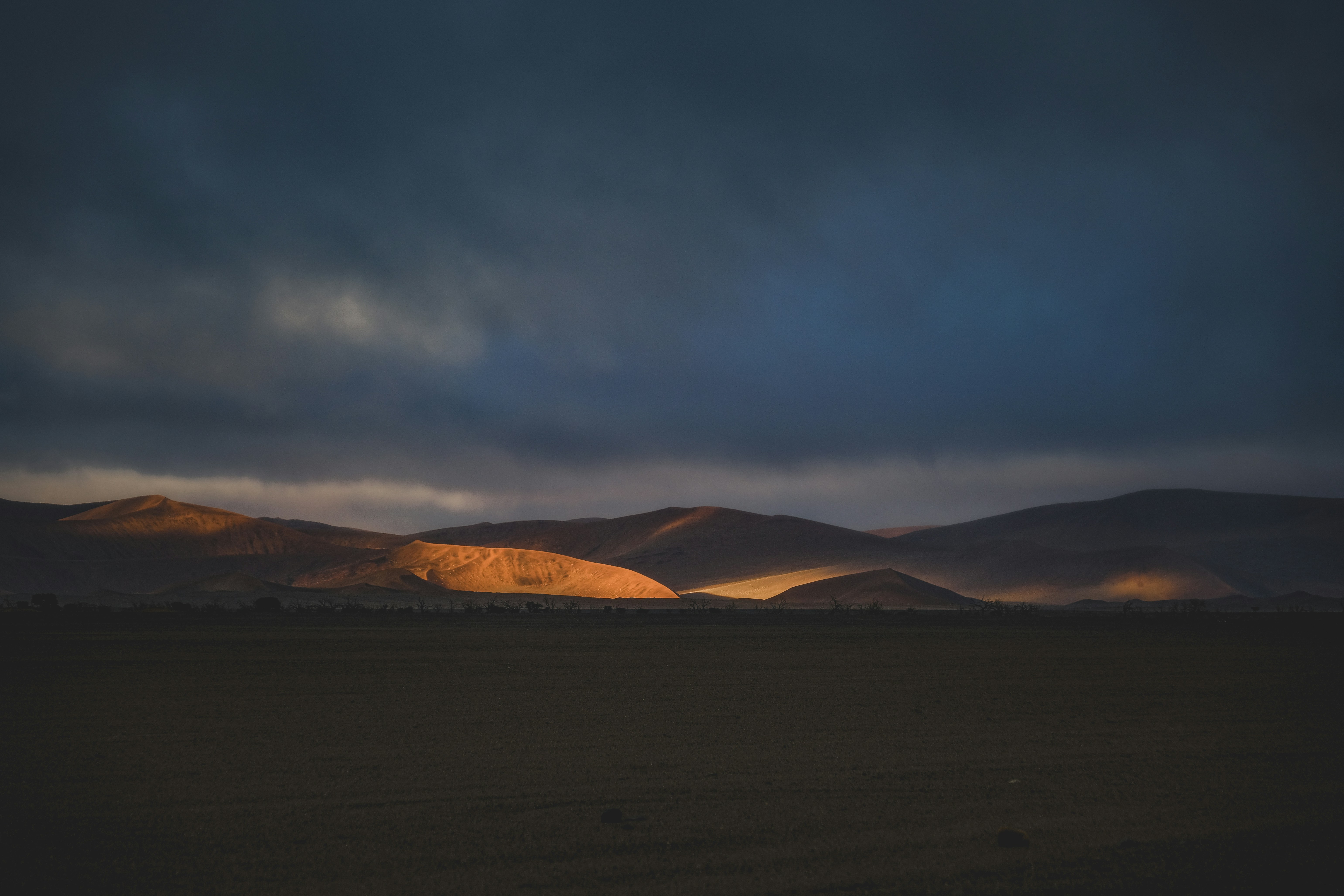 Low Sunlit Ridge: A Quiet Dusk over the Plains