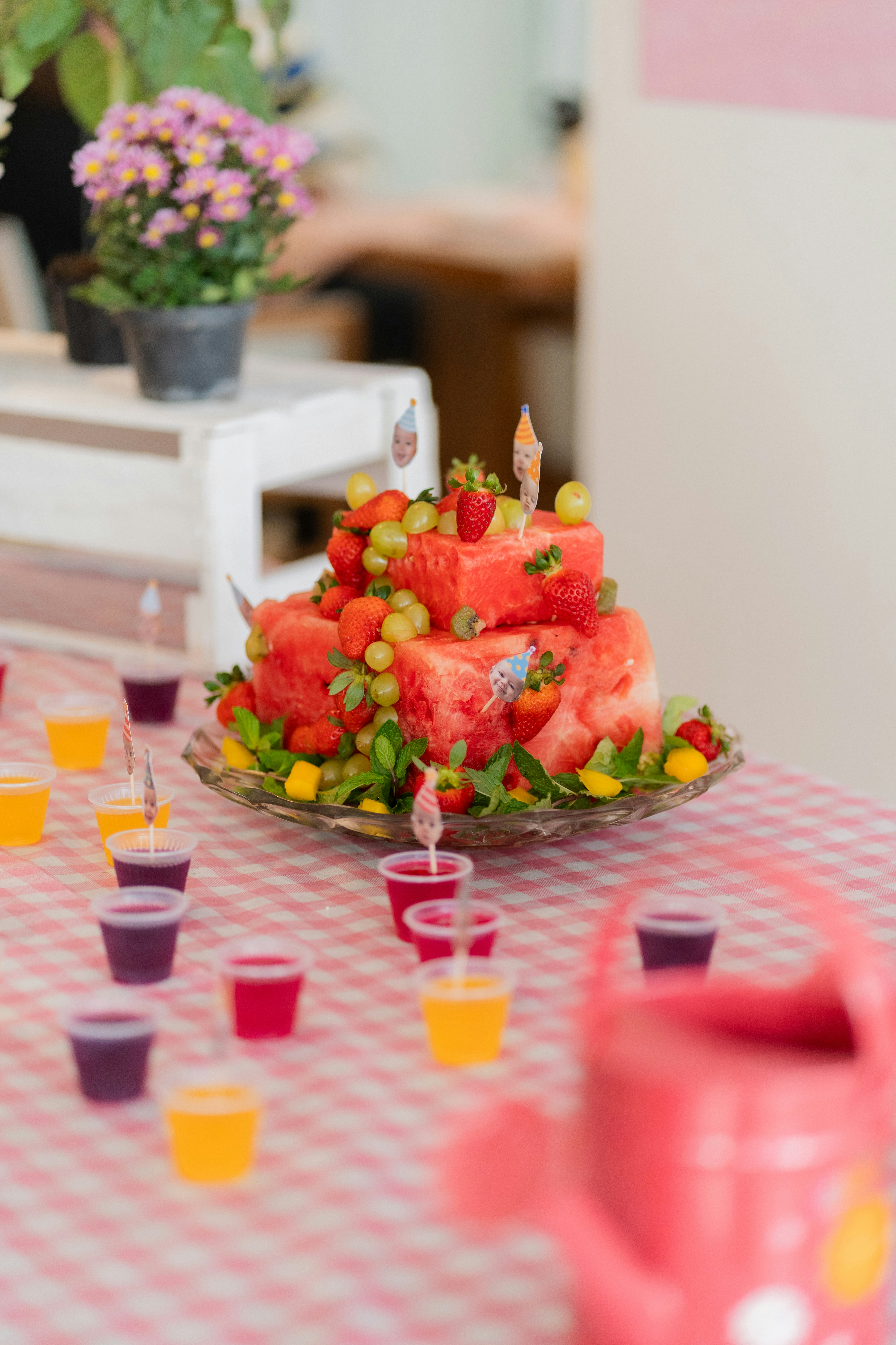 Watermelon-tiered Birthday Cake Surrounded by Citrus Tulips and Party Cups