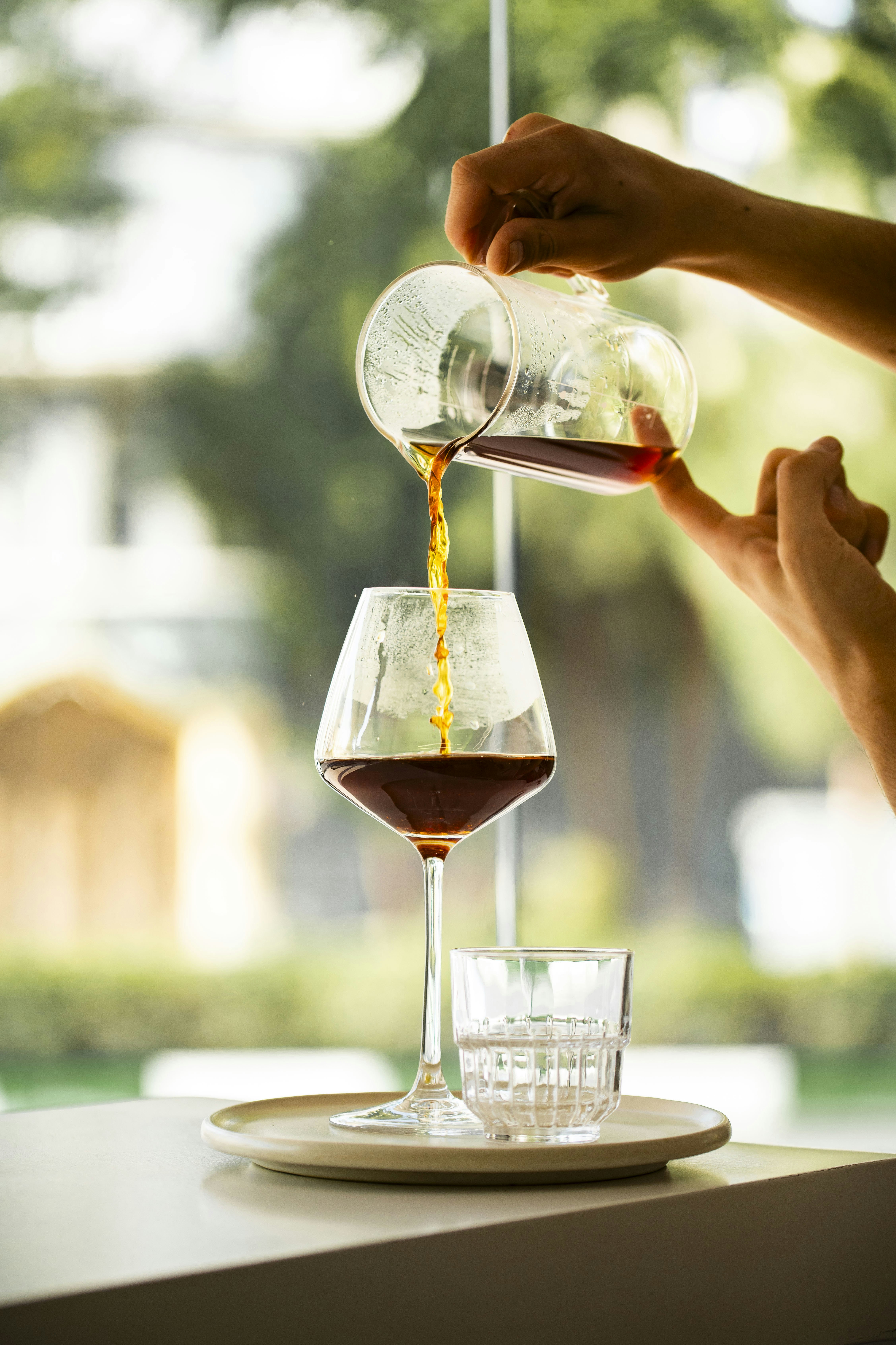 Pouring Warmth: A Wine Moment Through Glass and Light