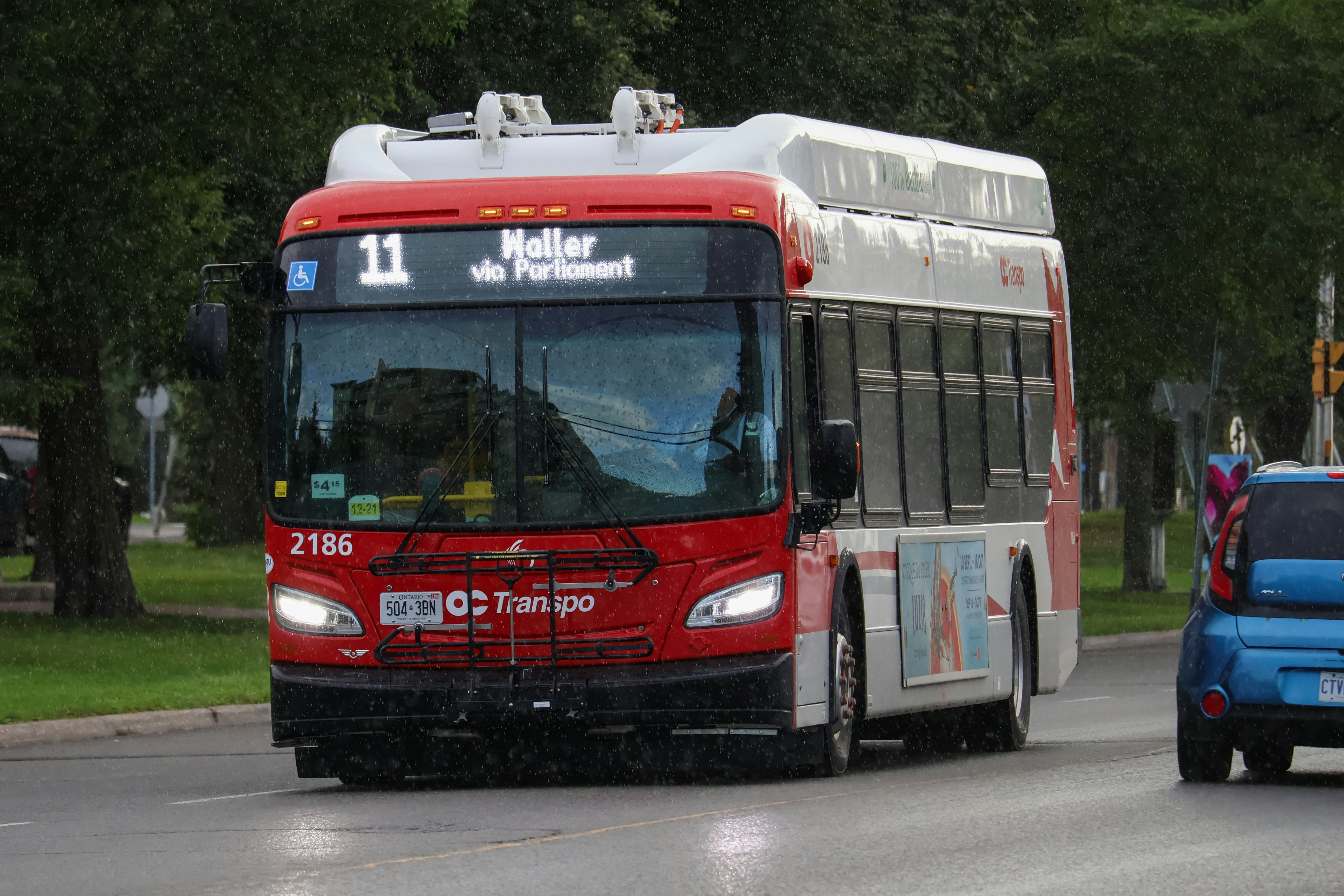 City Bus in Rain: Red Transit Gliding Through a Wet Street