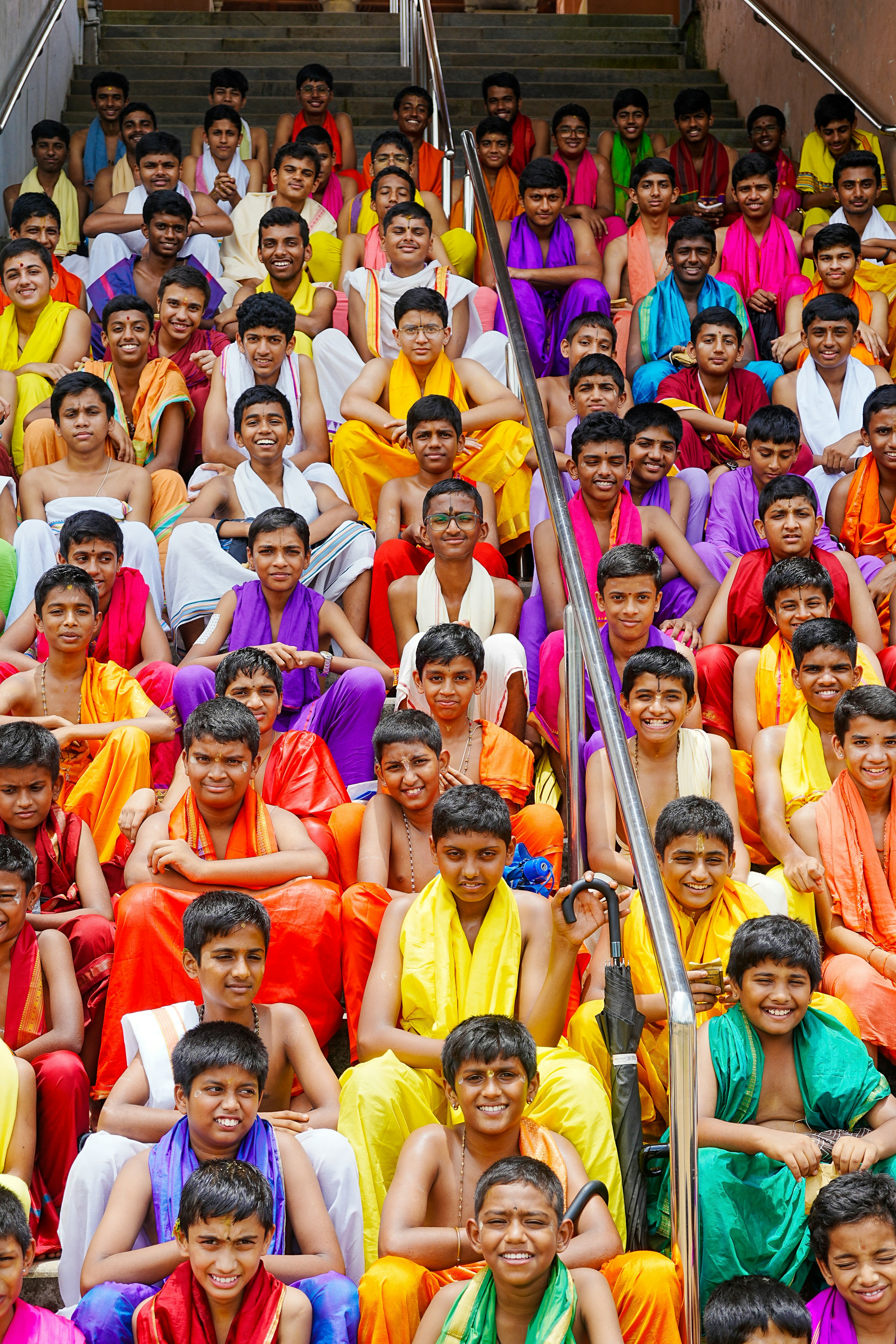 Sea of Safety: A Colorful Wave of Orange, Yellow, and Green Robes
