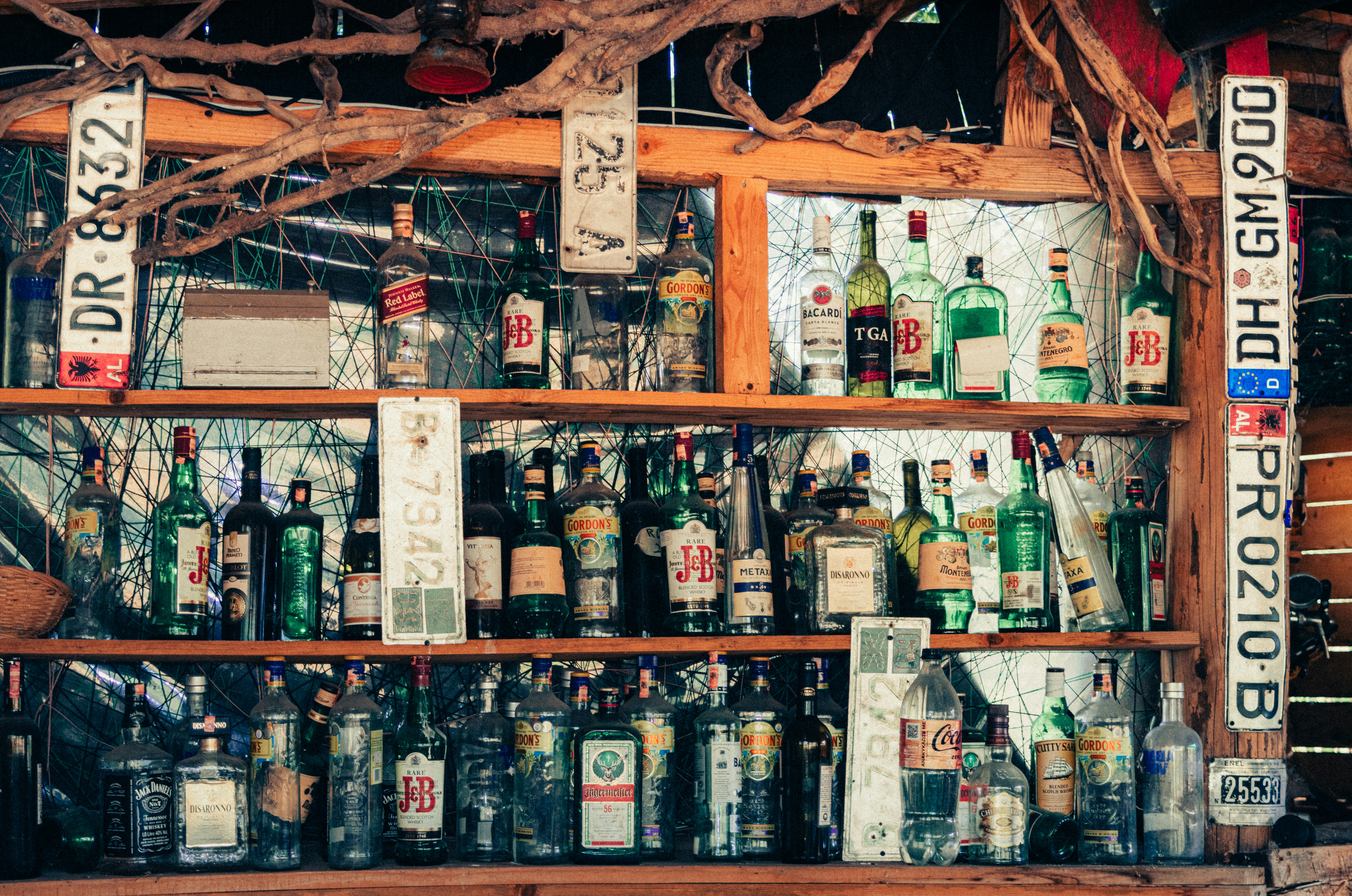 Shelf of Spirits: A Vintage Bar In Ragged Neon Light