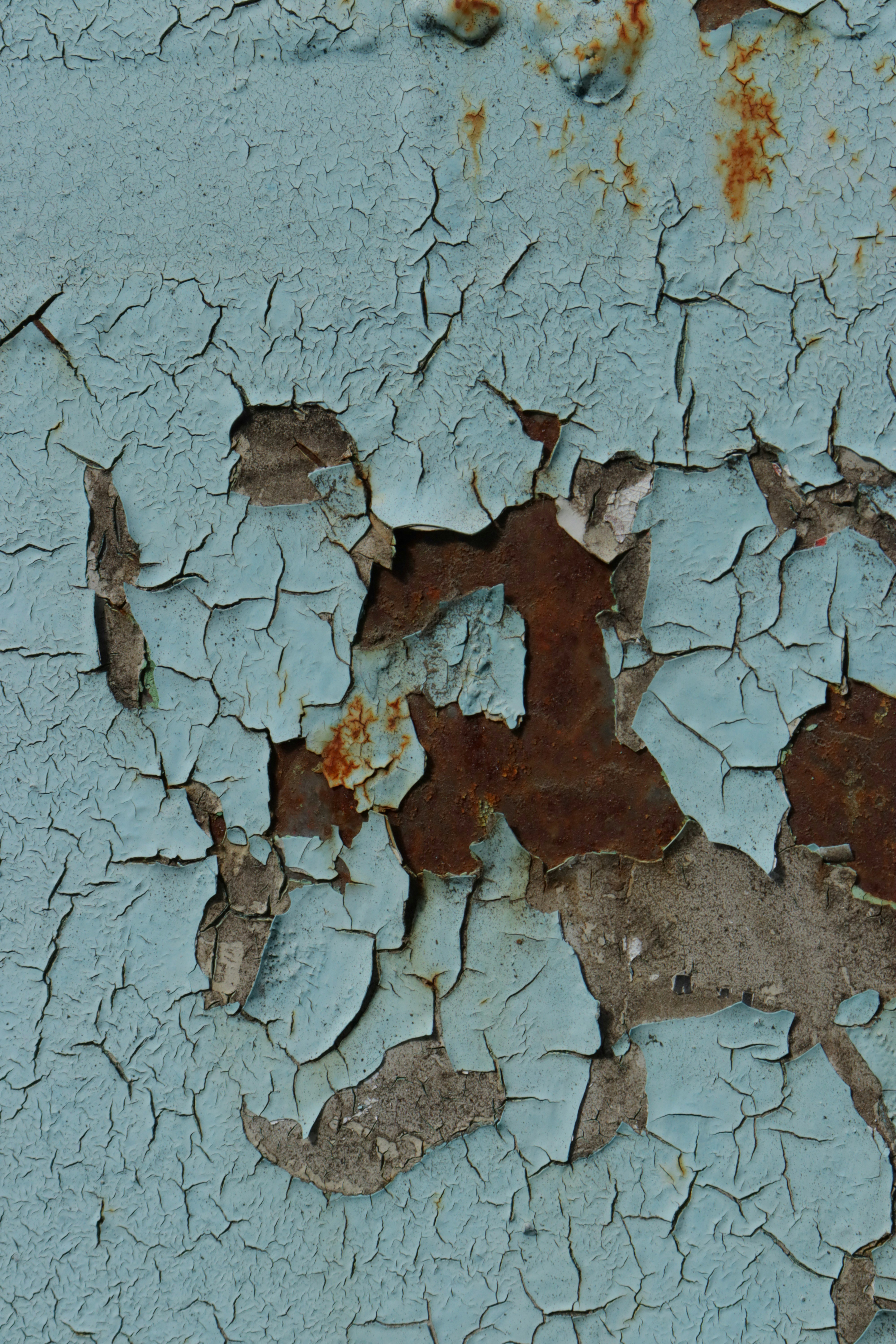 Peeling Turquoise Skin: Weathered Wall Portrait in Cracked Paint