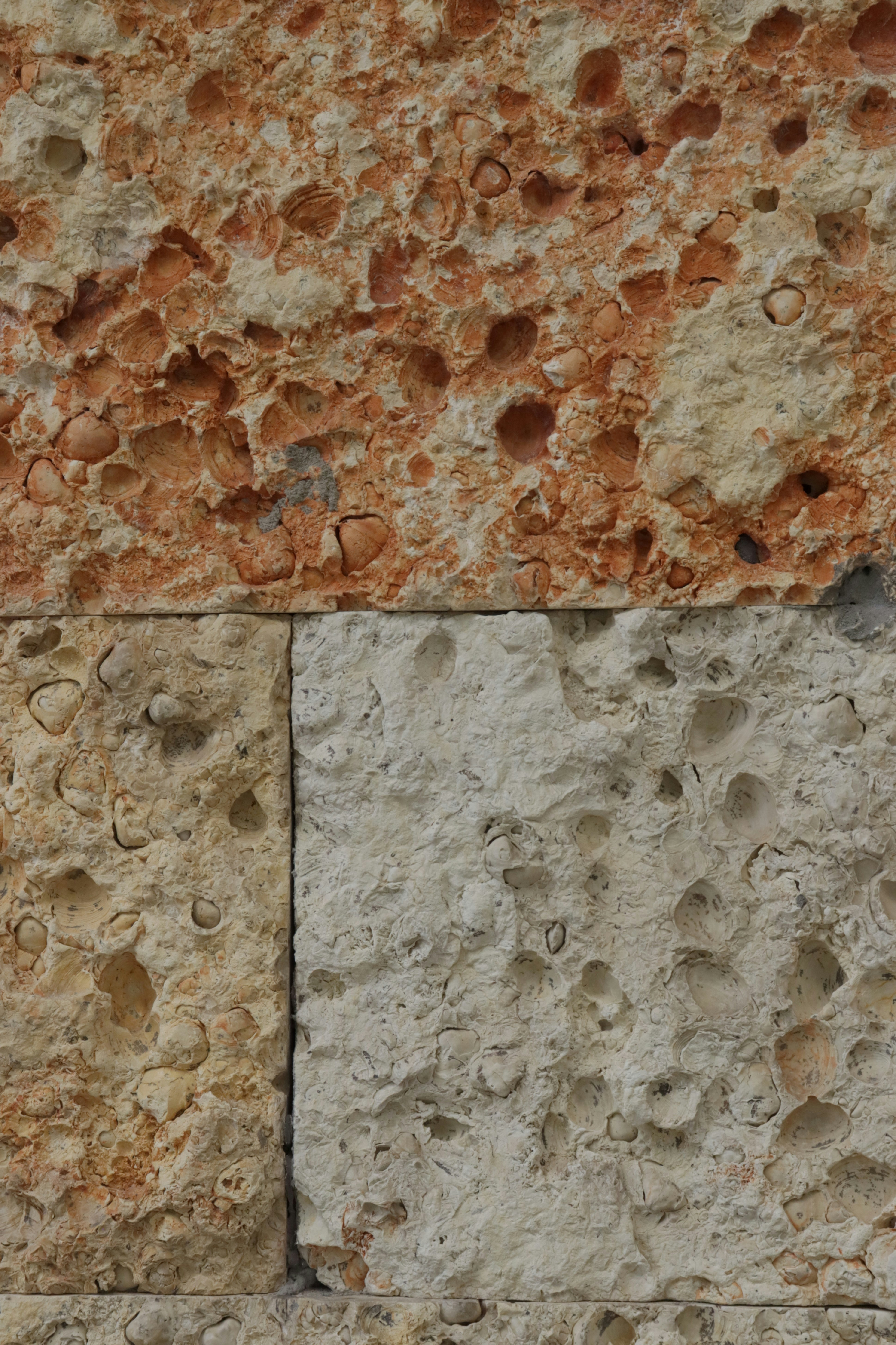 Stone Mosaic: A Weathered Wall of Pebbles and Pocks