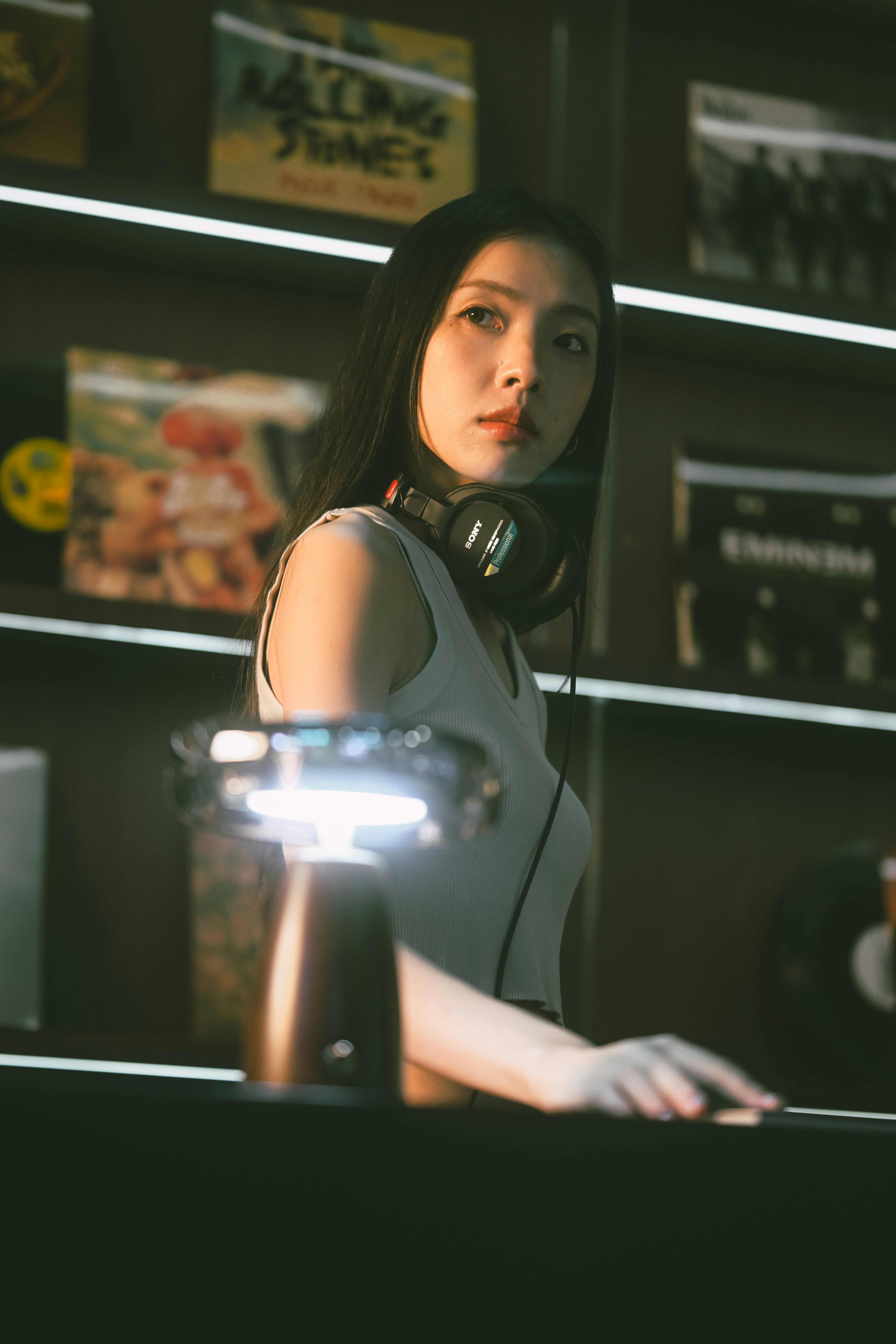 Neon-lit booth, headphones resting at the ready