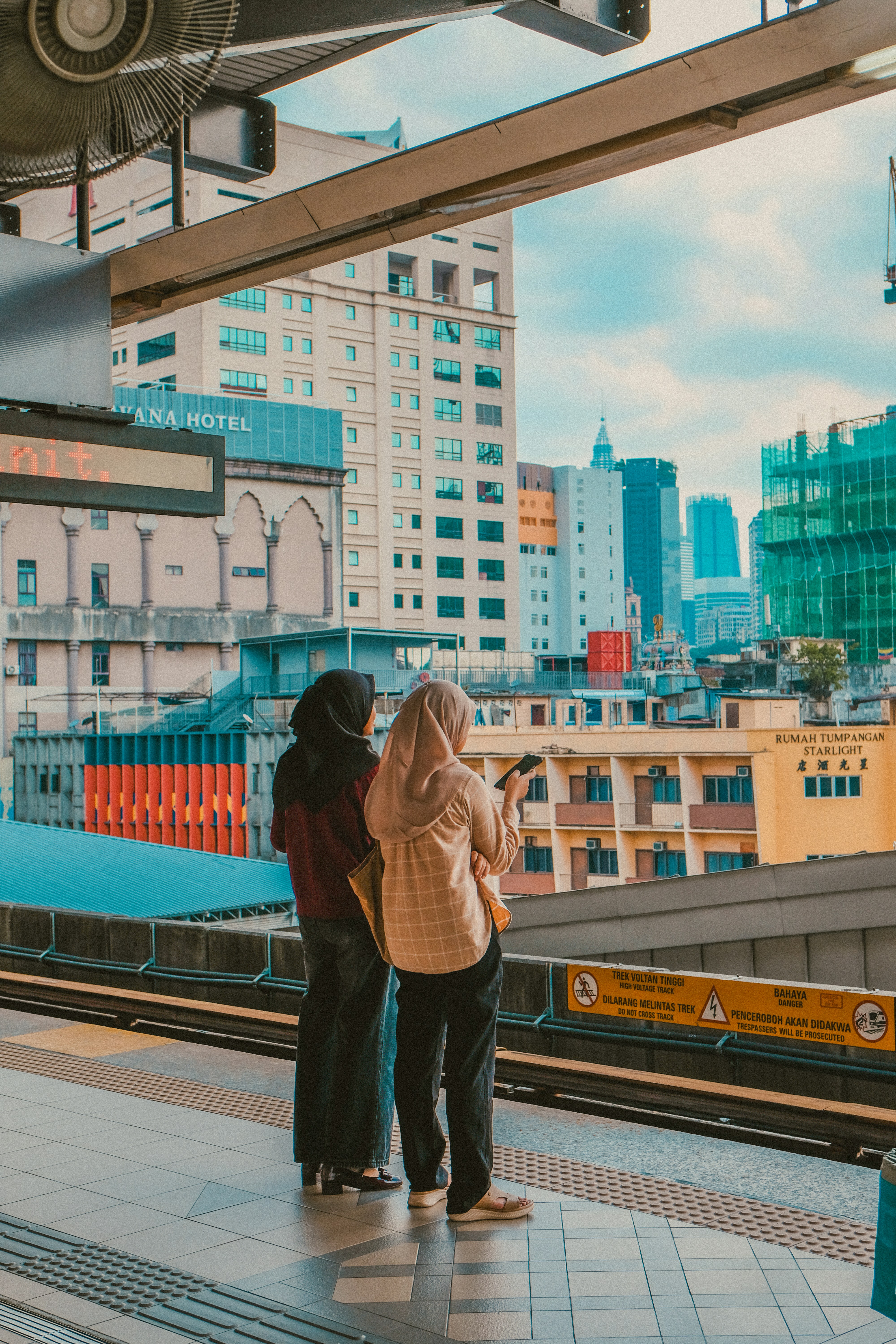 City Glass and Threads: Two Women on a Rooftop Platform