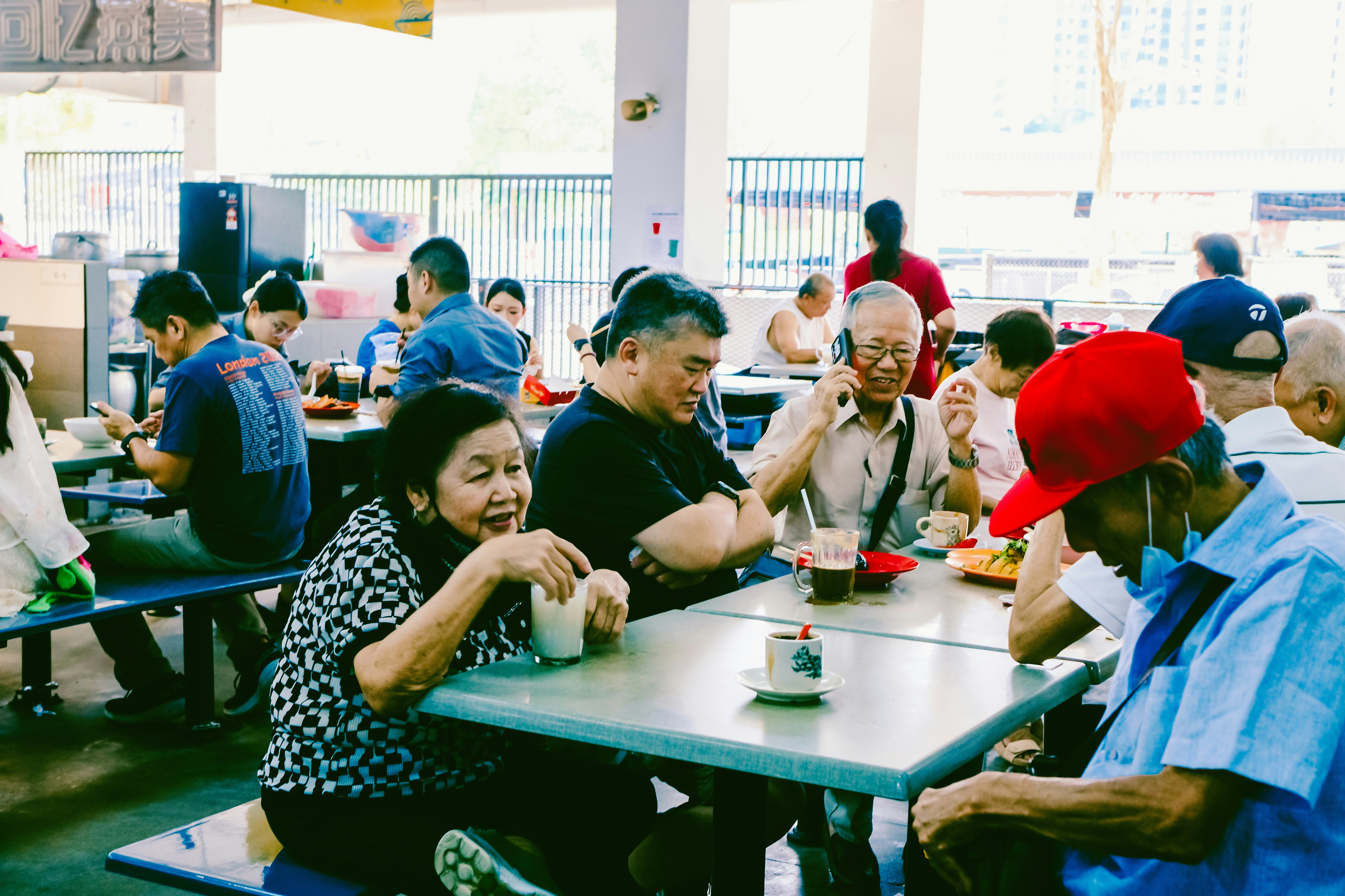 A Shared Moment at the Outdoor Café: Elderly Friends in Conversation