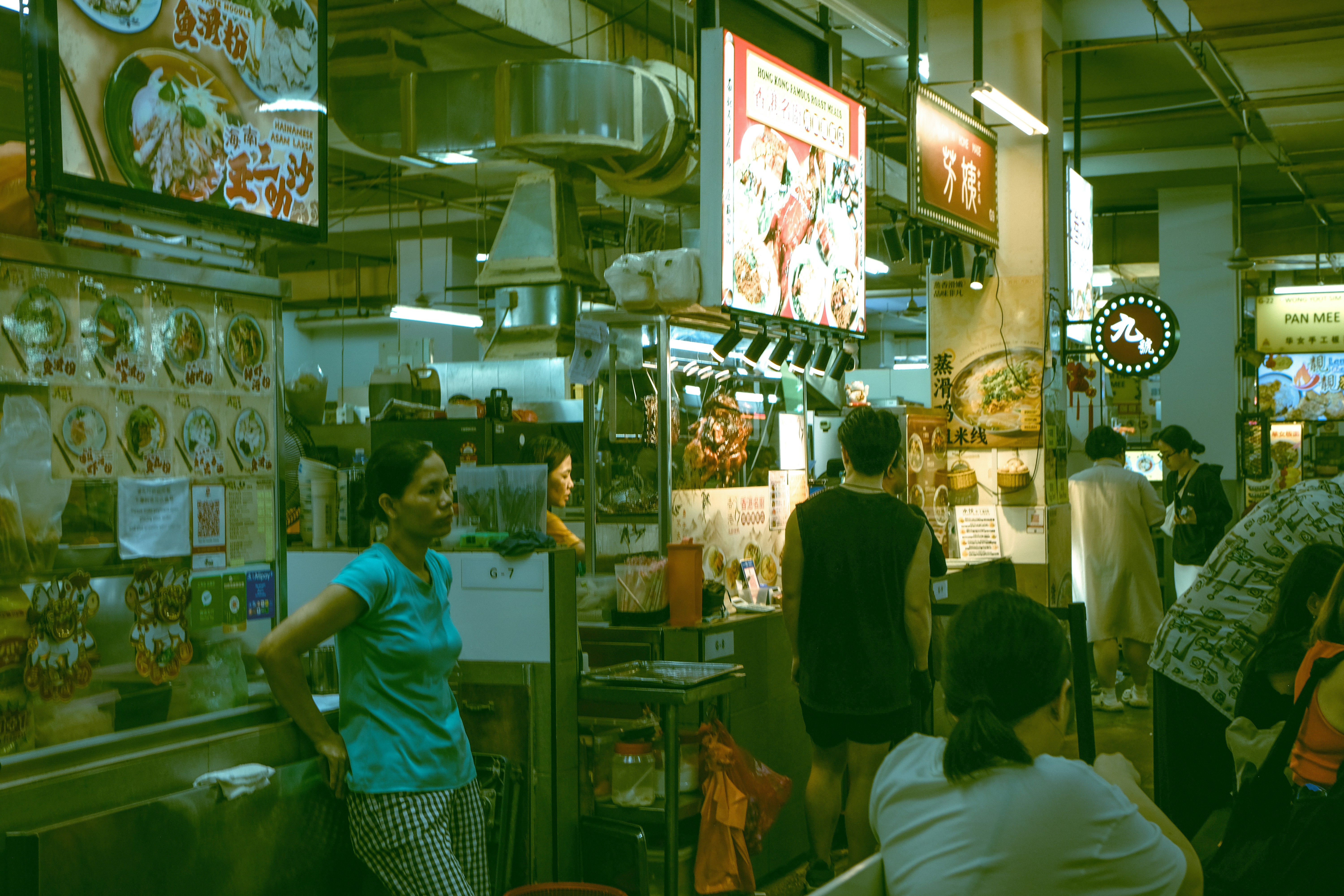 Lanterns and steam: a busy hawker stall in a neon-lit market