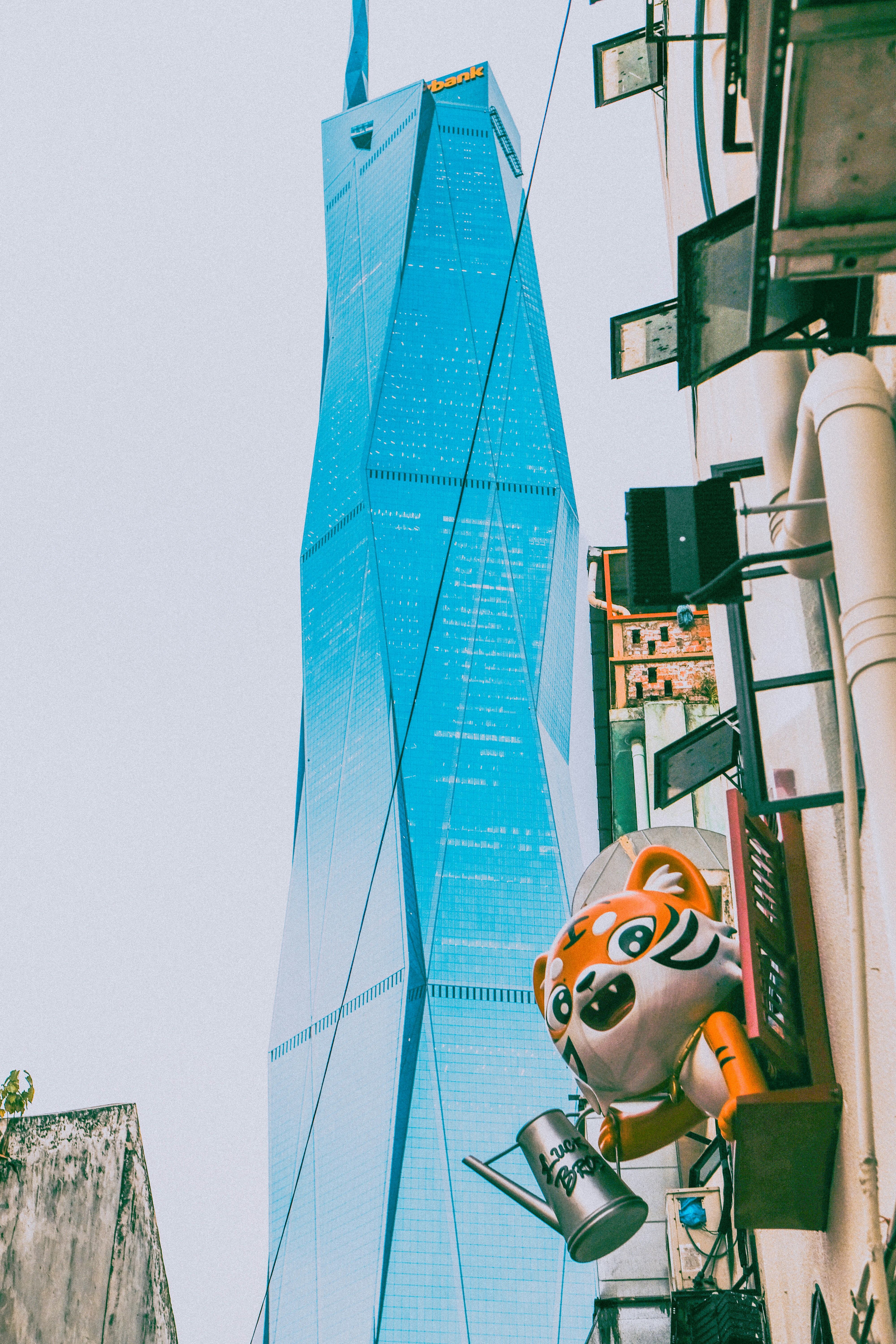 Skyward Glass: A Blue Tower Reflected in Busy Street