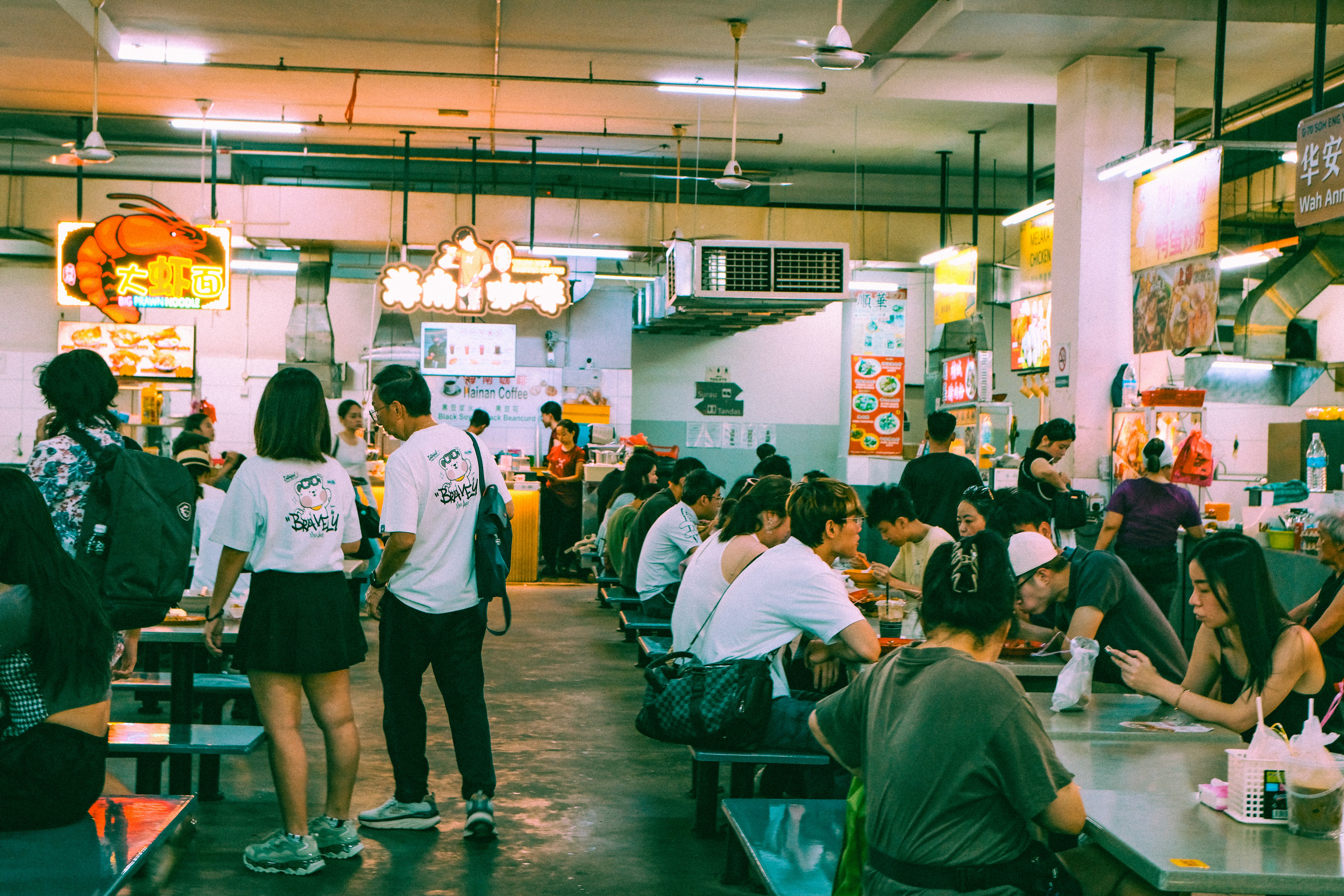 Bustling Food Court Serenade: People, Plates, and Neon at Dusk