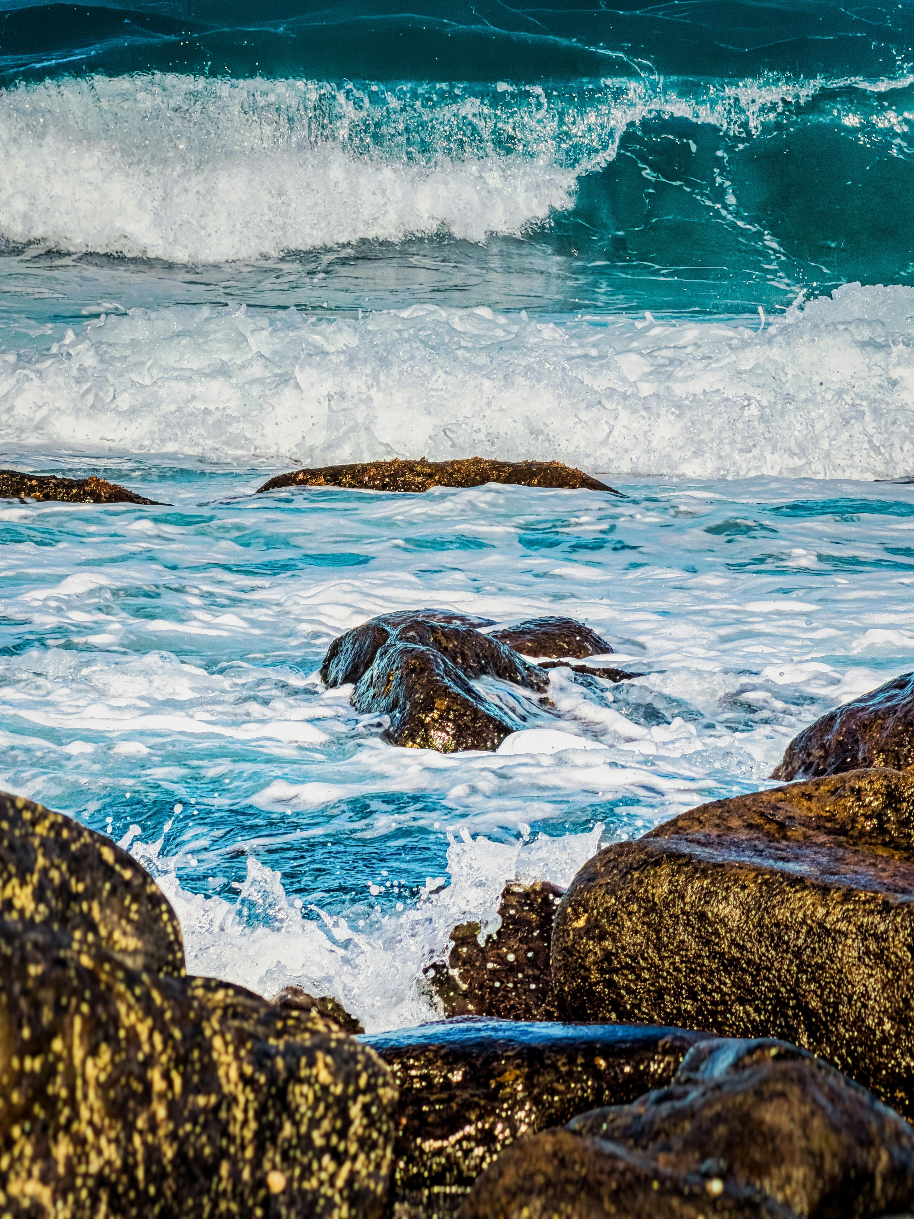 Crashing blues over weathered stones