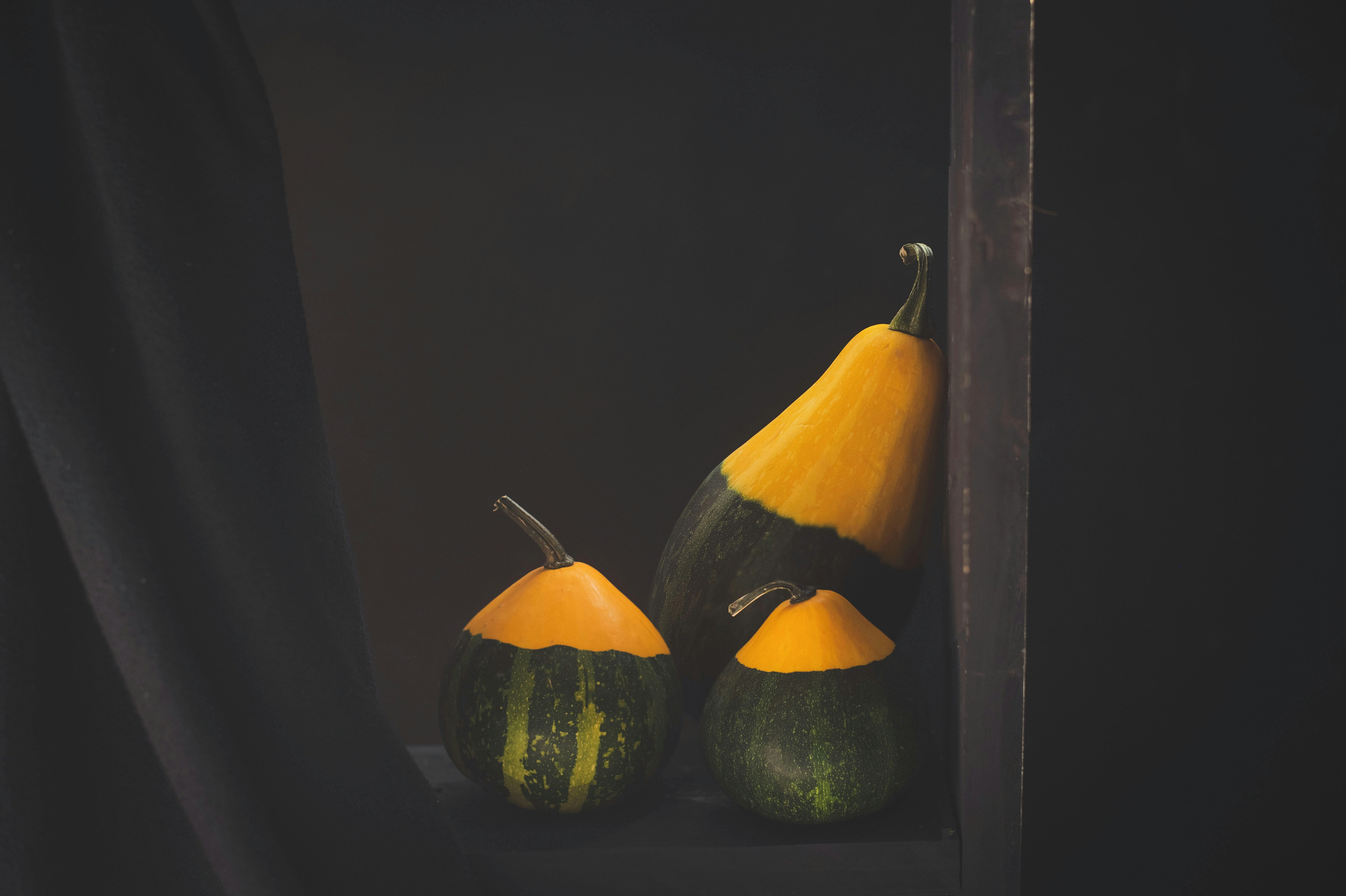 Hidden Harvest: trio of gourds resting in a dim cabinet