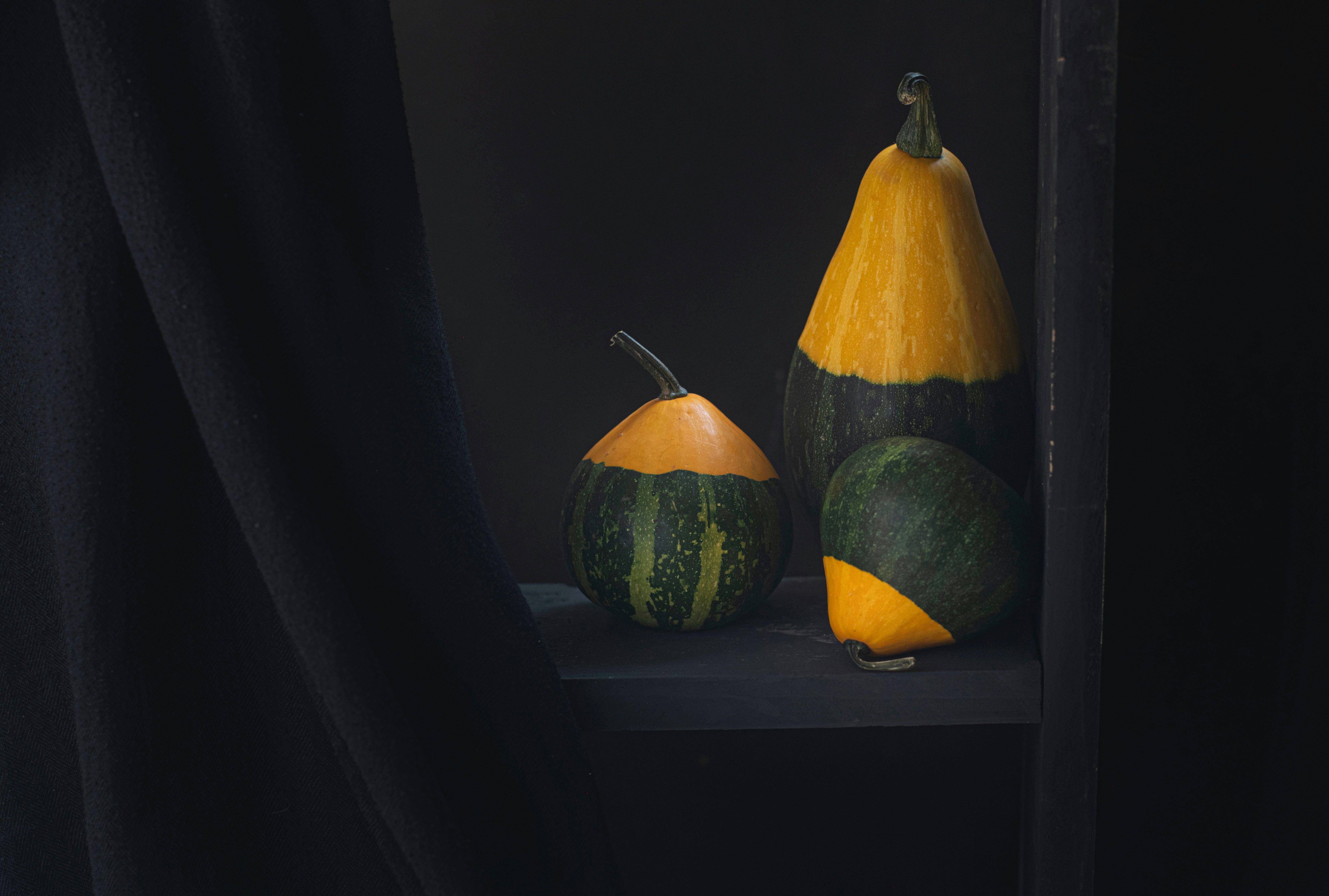 Striped gourds on a shelf: a quiet still life in shadow