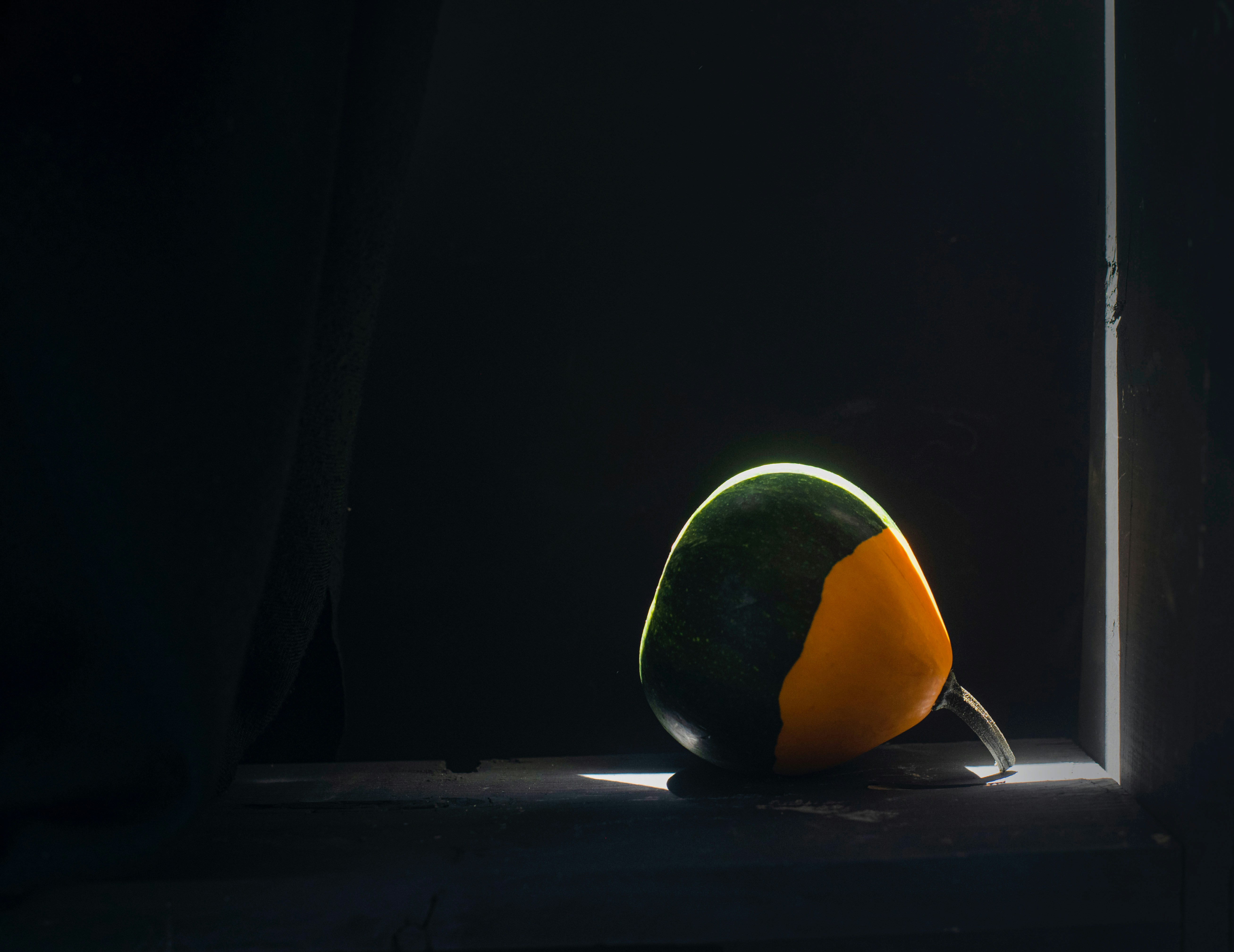 A Mango Under a Sliver of Window Light