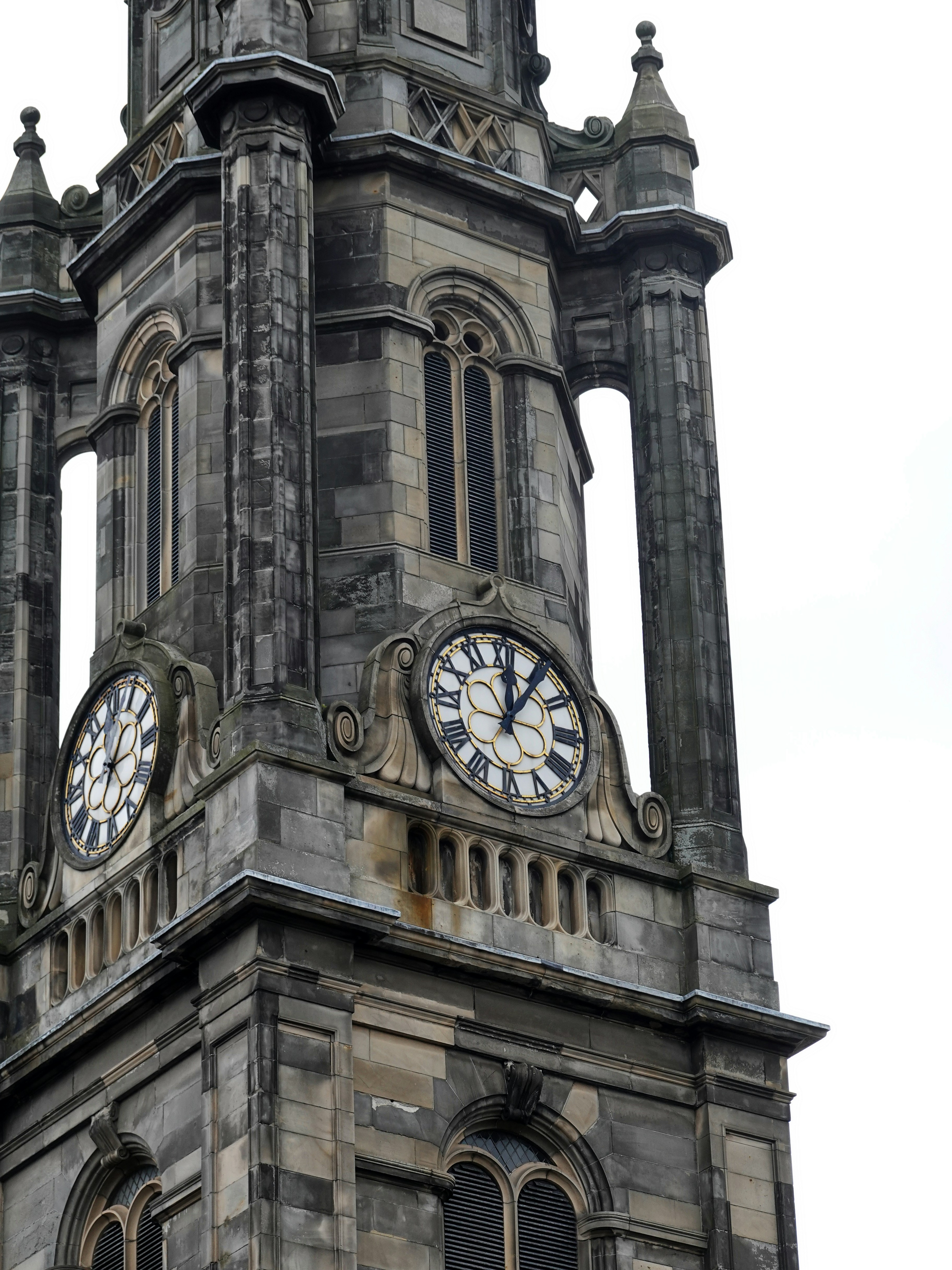 Clock Tower Details: Weathered Stone and Roman Numerals