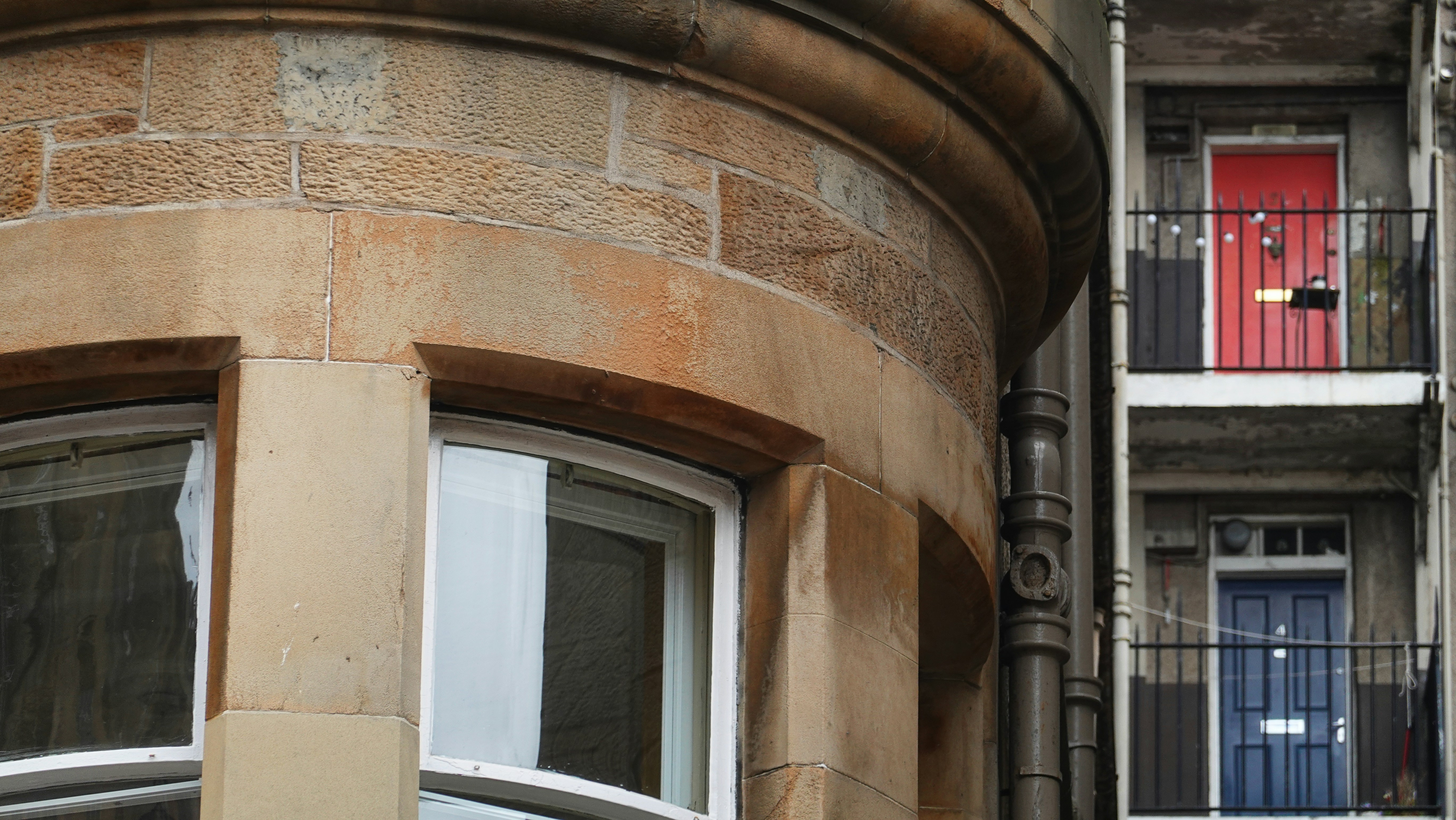 Corner Architecture: A Red Door Framed by Historic Stonework