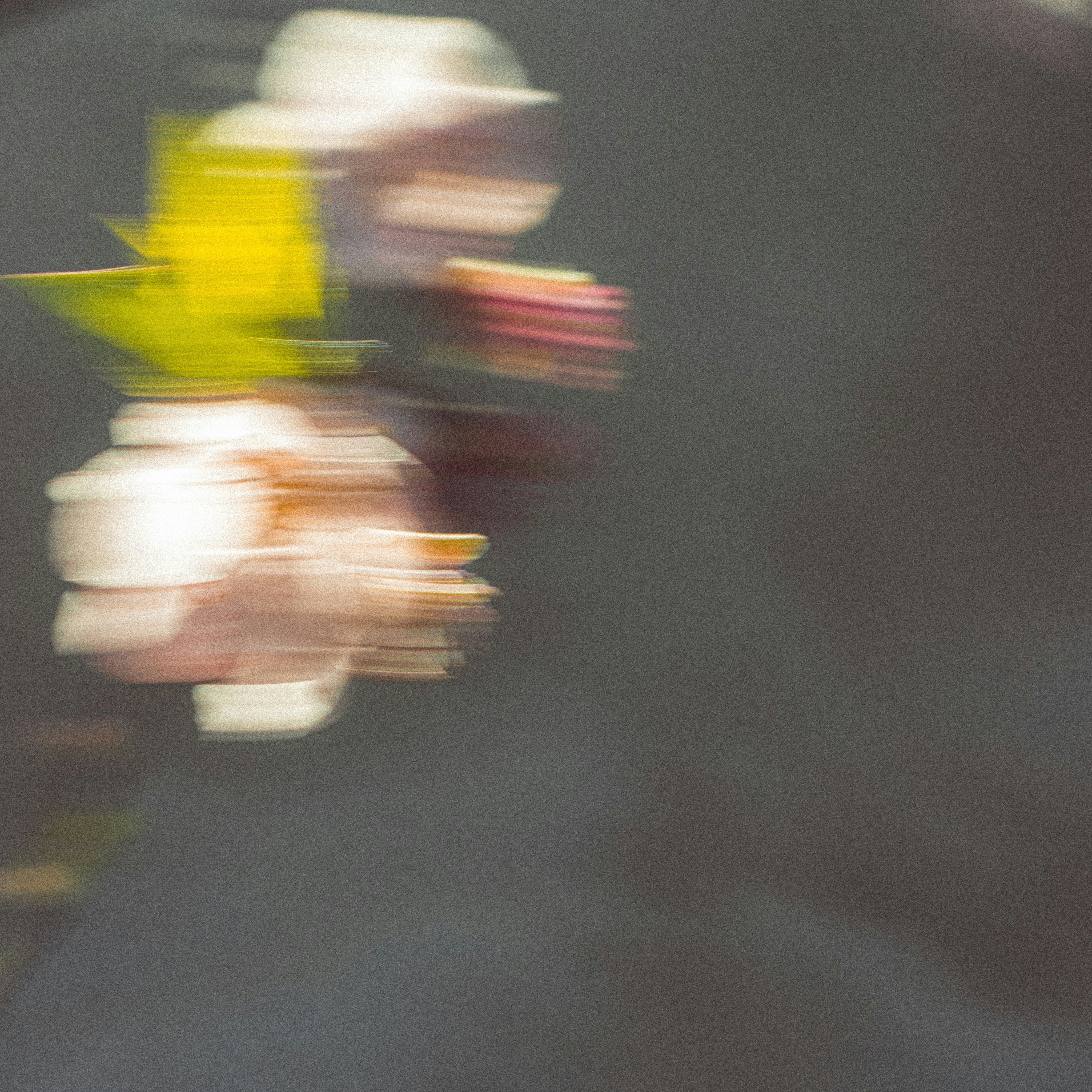 Blurred Motion of a Multicolored Figure in a Dim Scene
