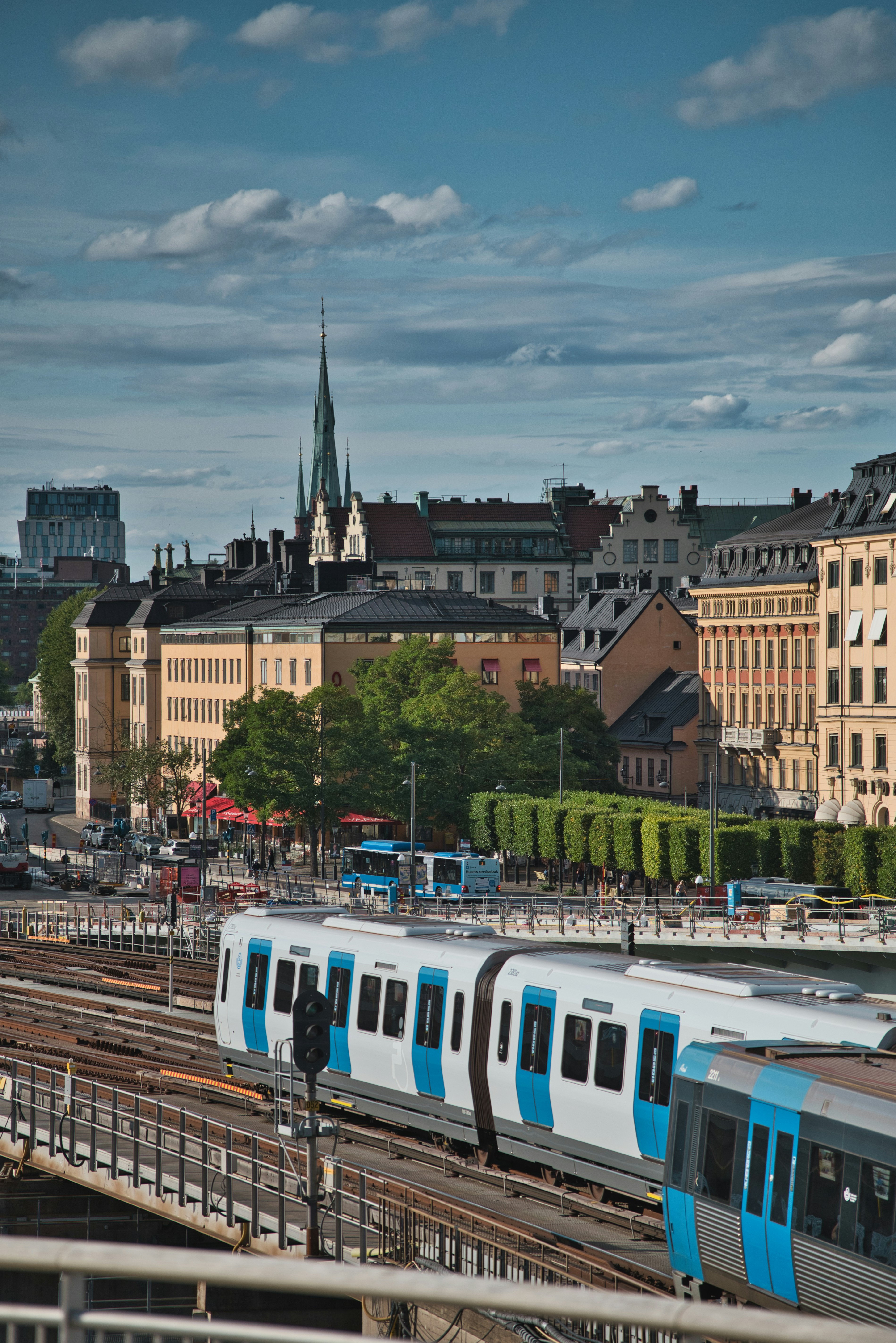 Rails and Rooftops: A City Train Carries Through a Historic Landscape