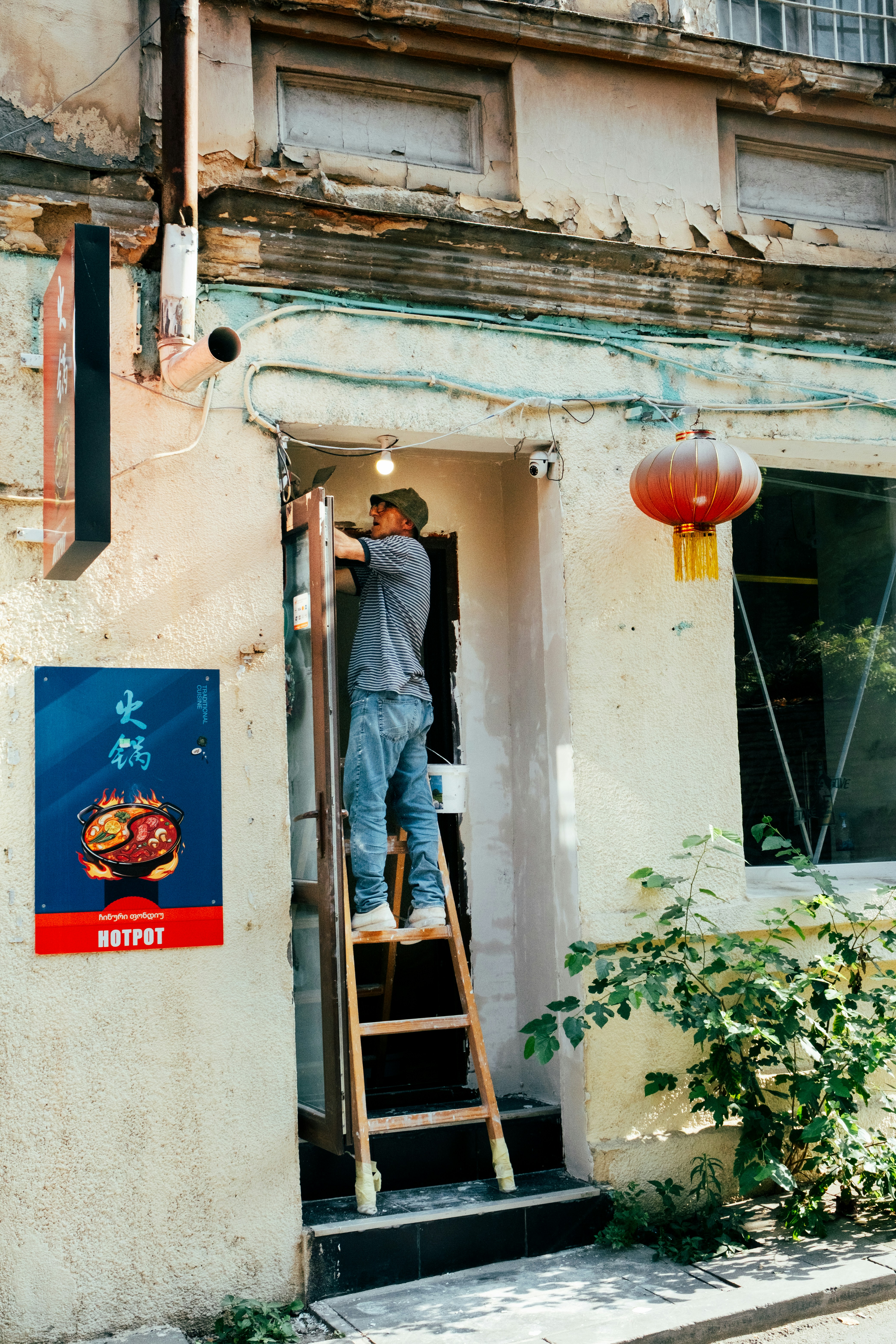 Ladder Work at a Sunlit Doorstep